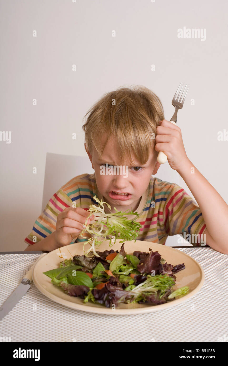 Boy Refusing to Eat Salad Stock Photo - Alamy
