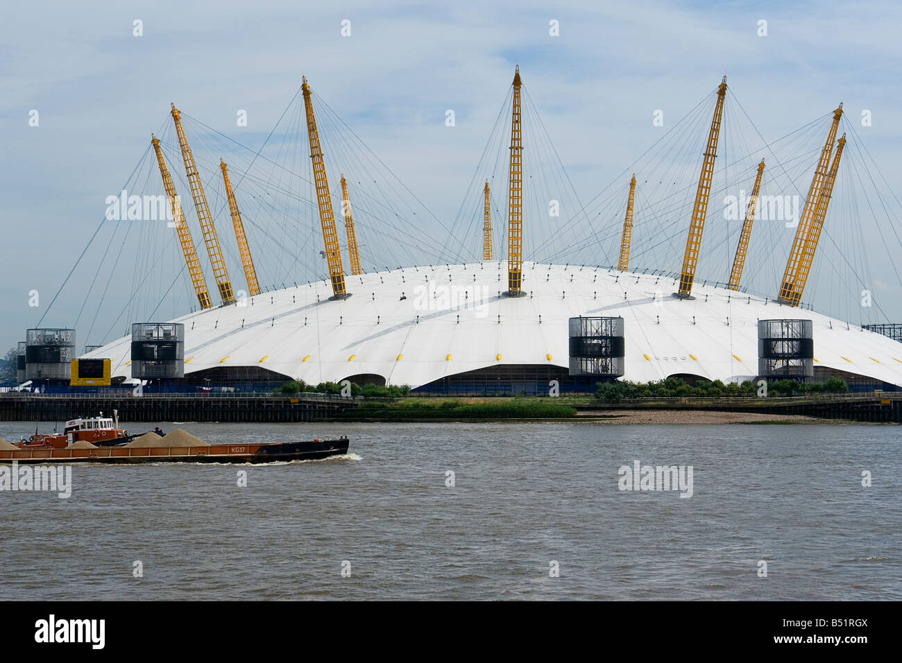 Millenium dome on river Thames with barge - London UK Stock Photo - Alamy