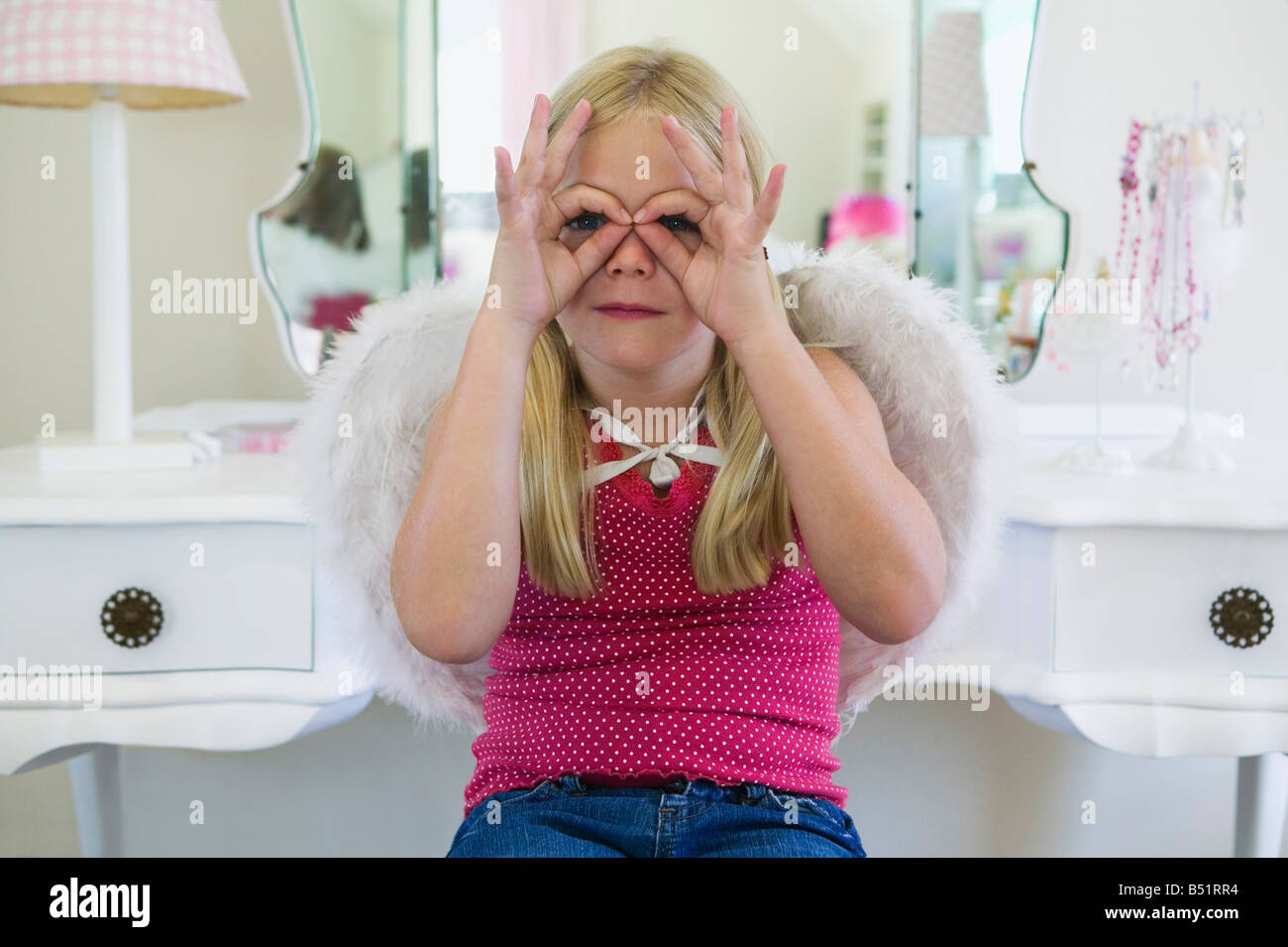 Young Girl Playing Peek-a-Boo with Her Fingers Stock Photo - Alamy