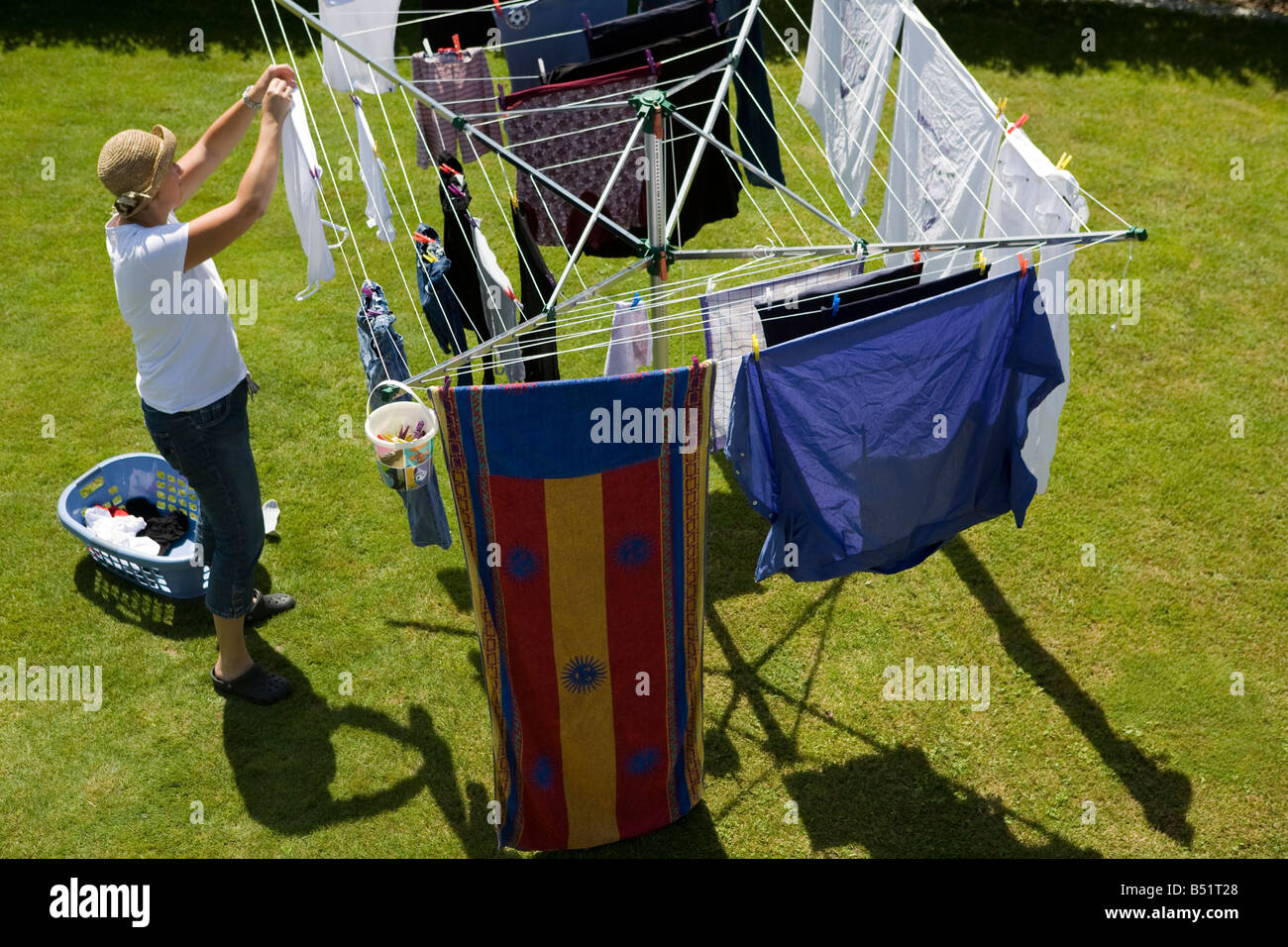 Woman hanging laundry Stock Photo - Alamy