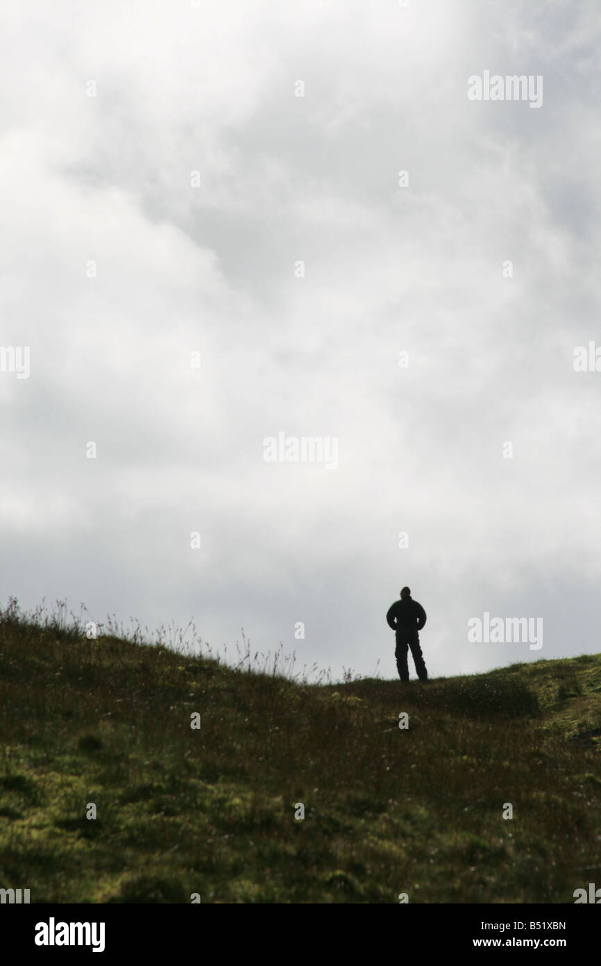 man walking on wild rugged rural mountain top Stock Photo - Alamy