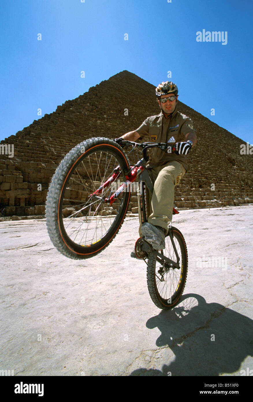 World Champion mountain biker Hans Rey riding at the Pyramids Giza ...