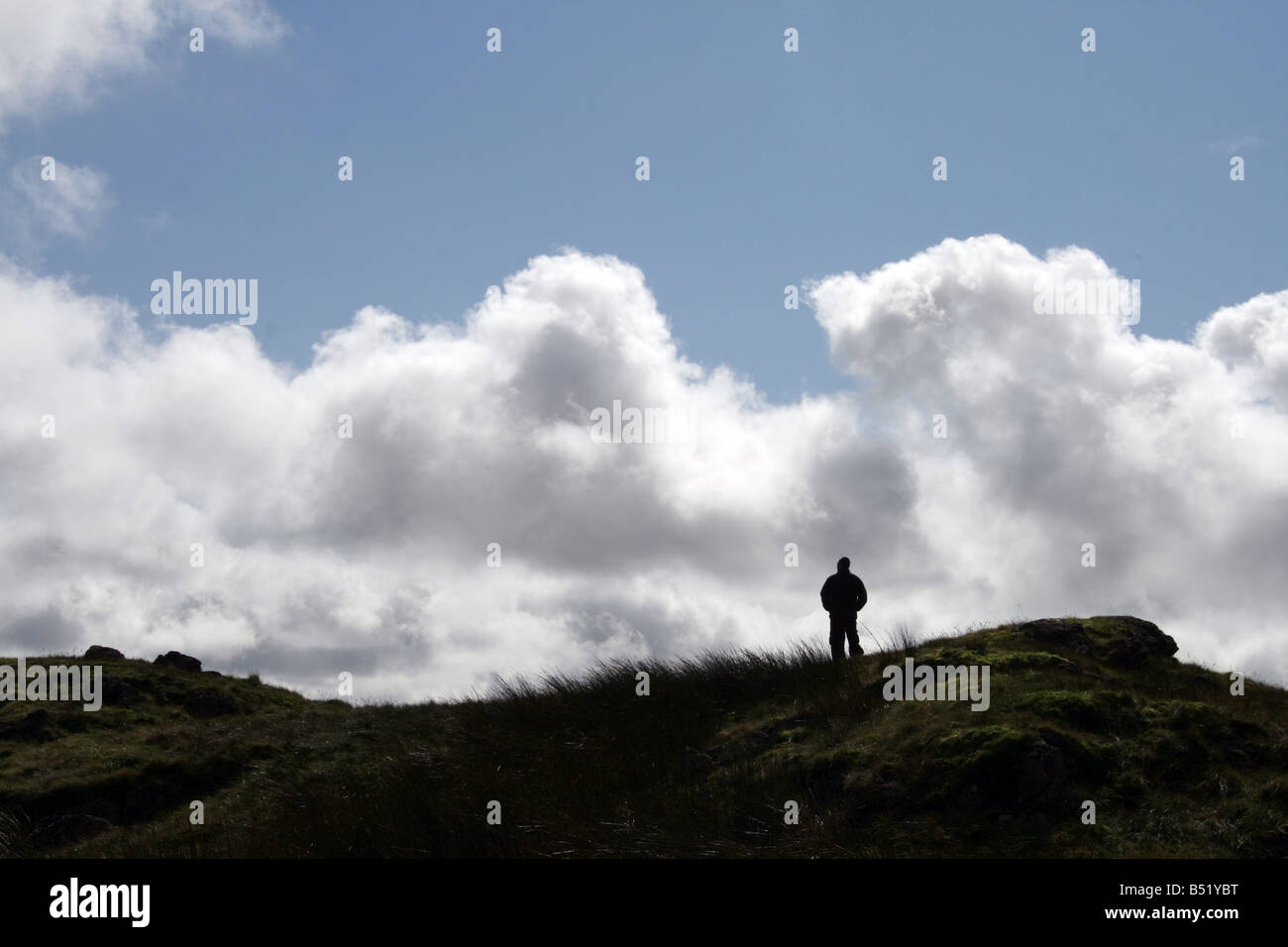 man walking on wild rugged rural mountain top Stock Photo - Alamy