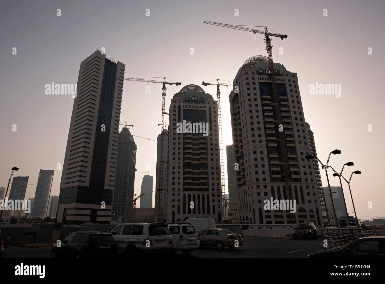 Doha new buildings being constructed at dusk Stock Photo - Alamy