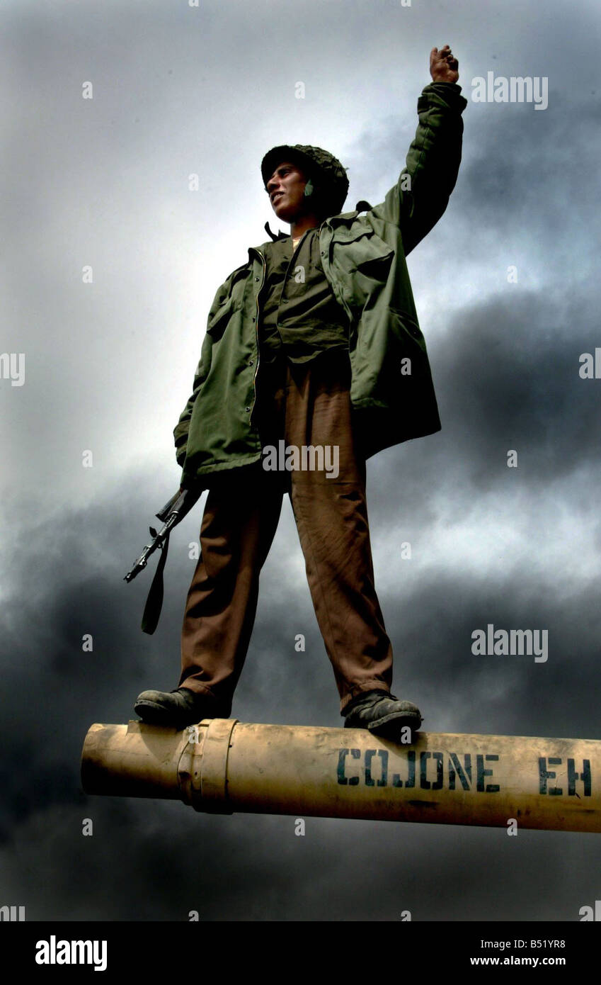IRAQ WAR 2003 An Iraqi soldier stands proudly on the barrel of what is ...