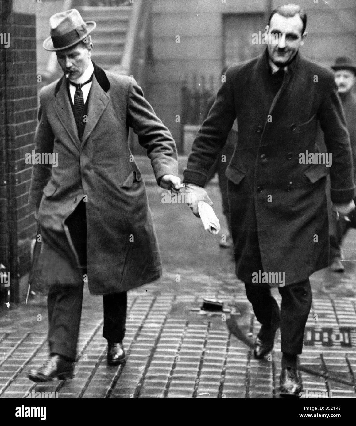 Escorted in handcuffs hi-res stock photography and images - Alamy