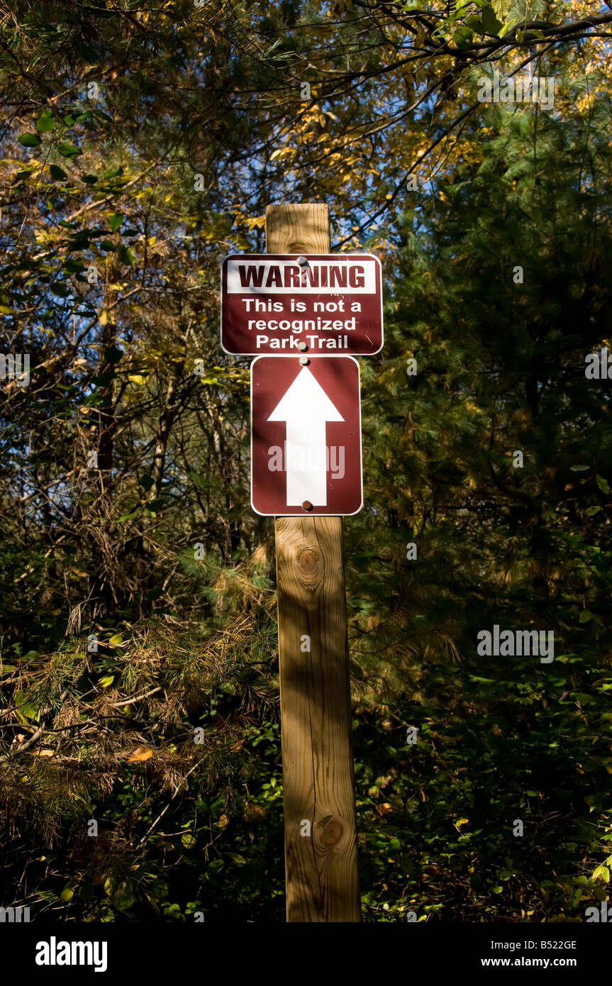 Sunlit warning sign in public park Stock Photo - Alamy