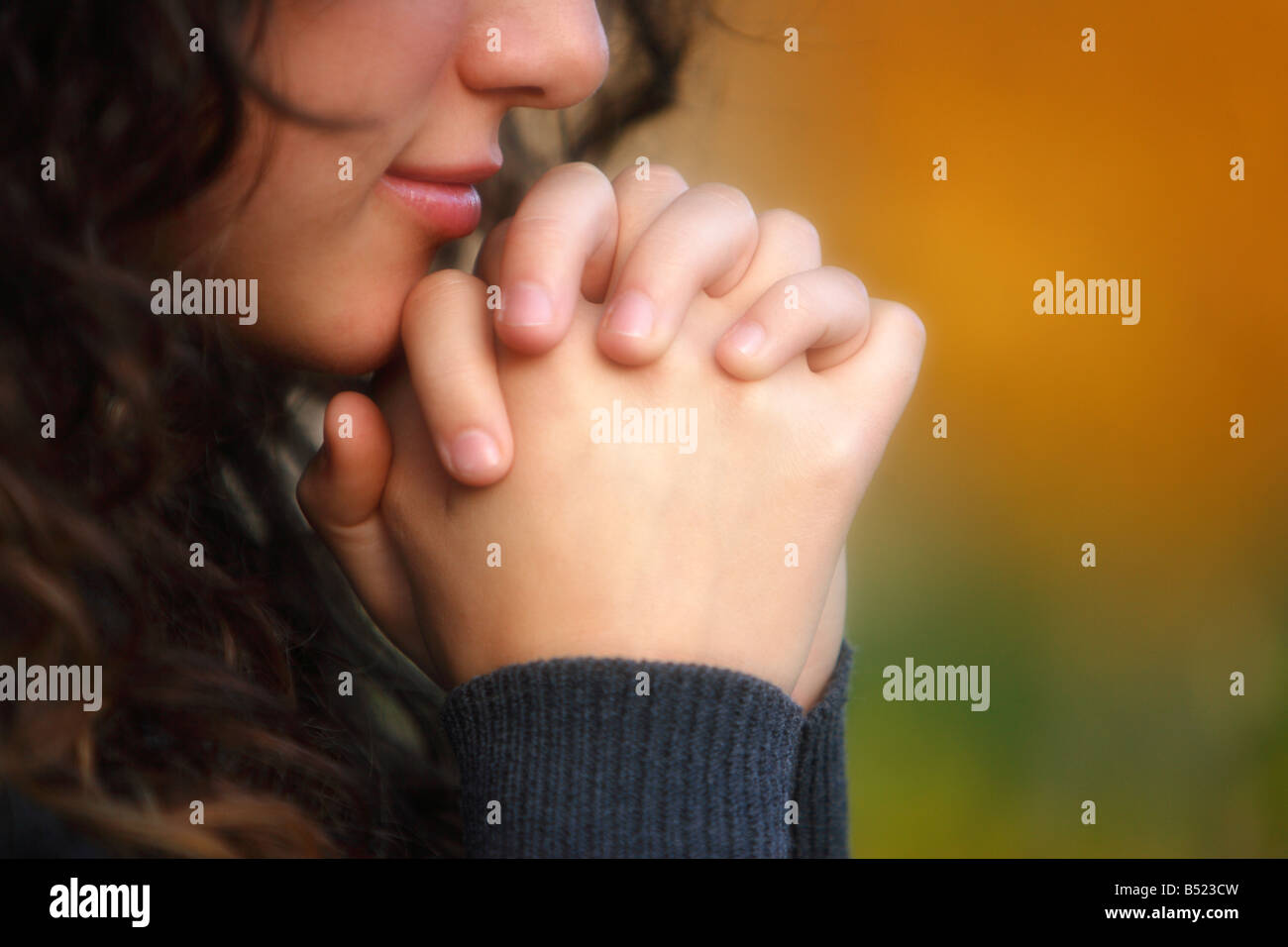 Young woman praying close up Stock Photo - Alamy