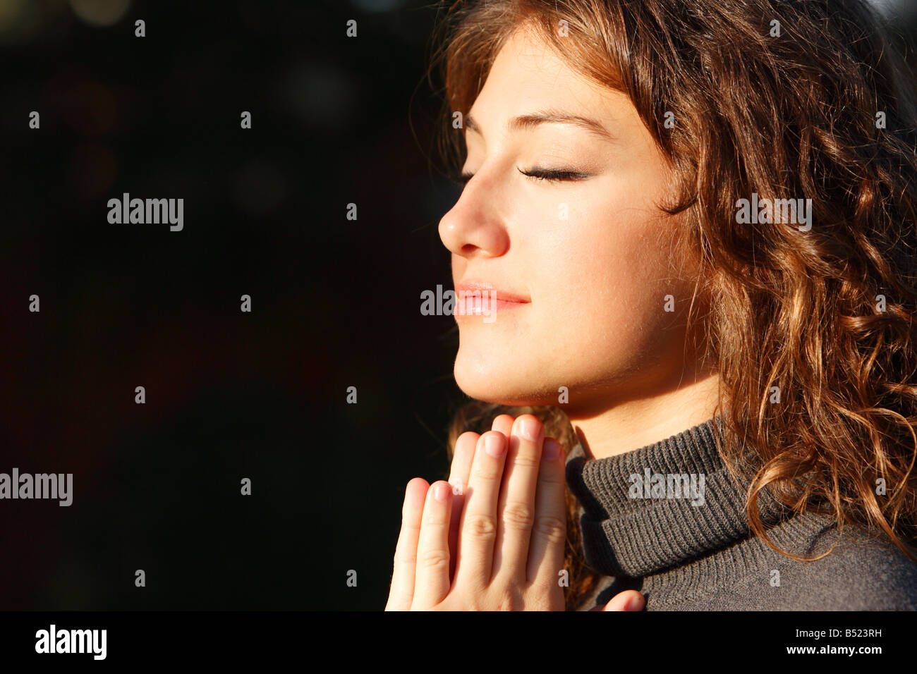 Young woman praying close up Stock Photo - Alamy
