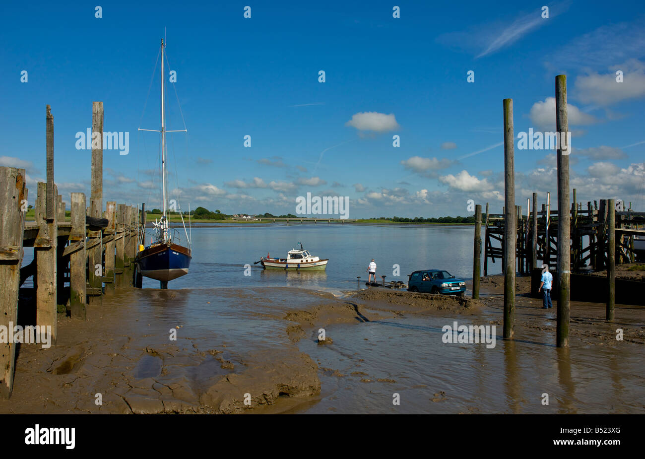 Three men launching a boat from a trailer on the River Wyre near ...