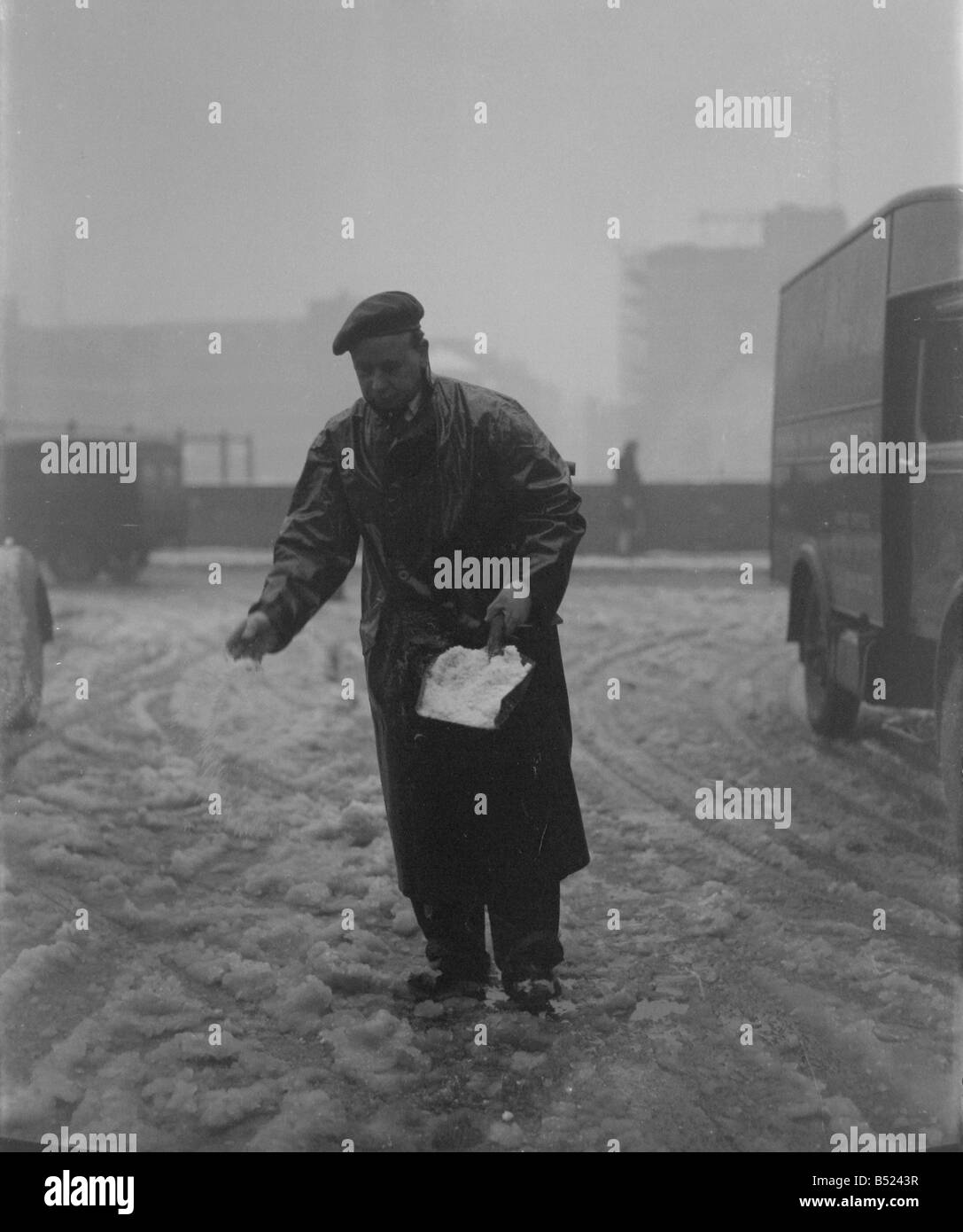 Snow scenes in London -;Man springling salt on snow in Fetter Lane;DM 3 ...