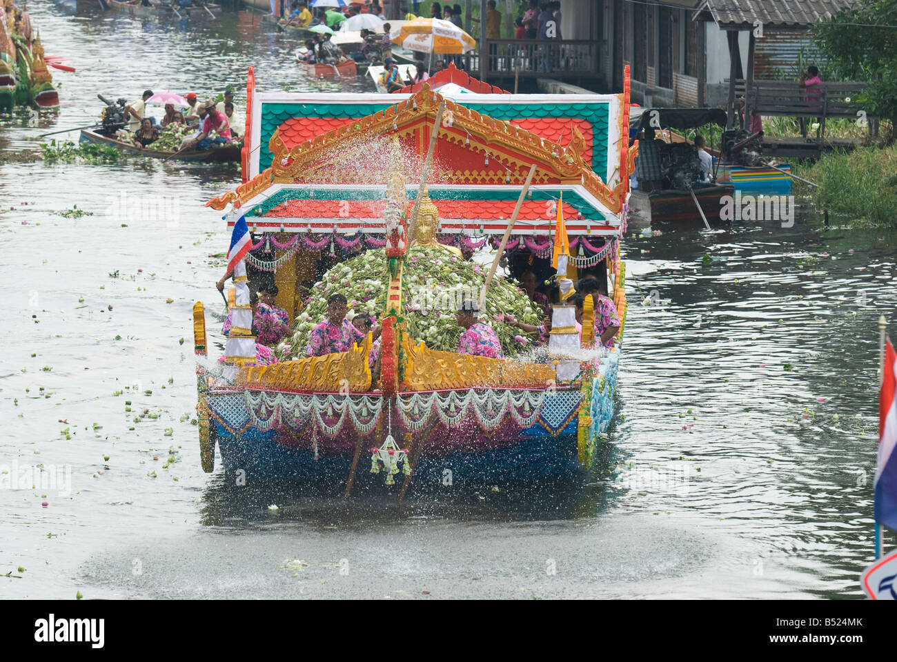 The floating Buddha image covered in lotus flowers on decorated barge ...