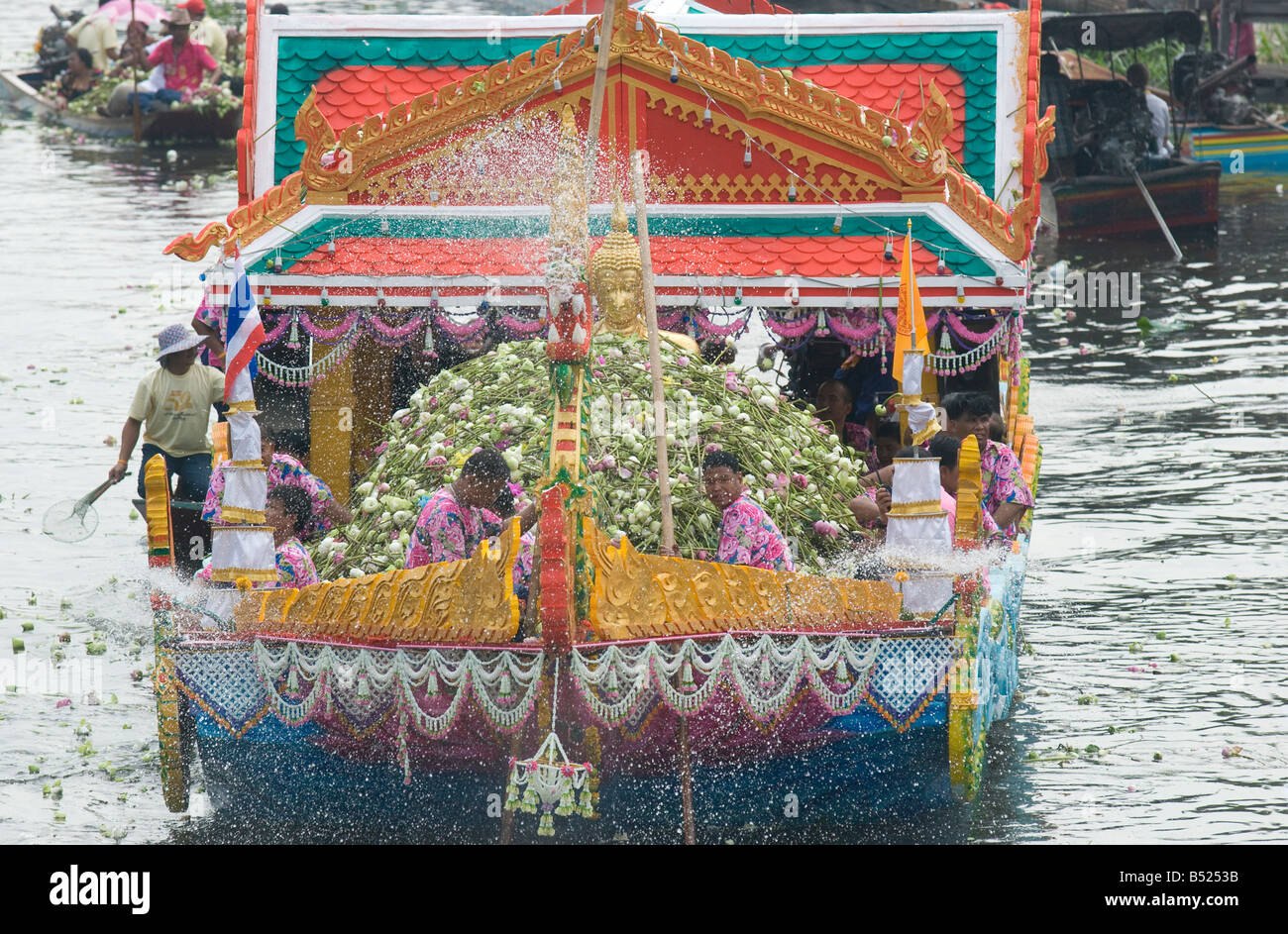 The floating Buddha image covered in lotus flowers on decorated barge ...