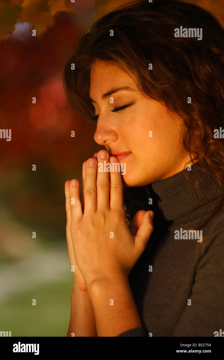 Young woman praying close up Stock Photo - Alamy