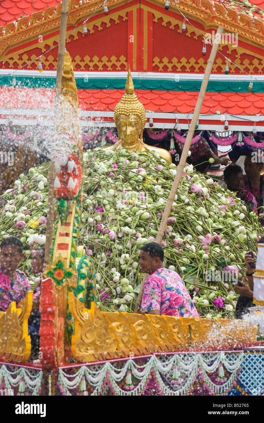 The floating Buddha image covered in lotus flowers on decorated barge ...