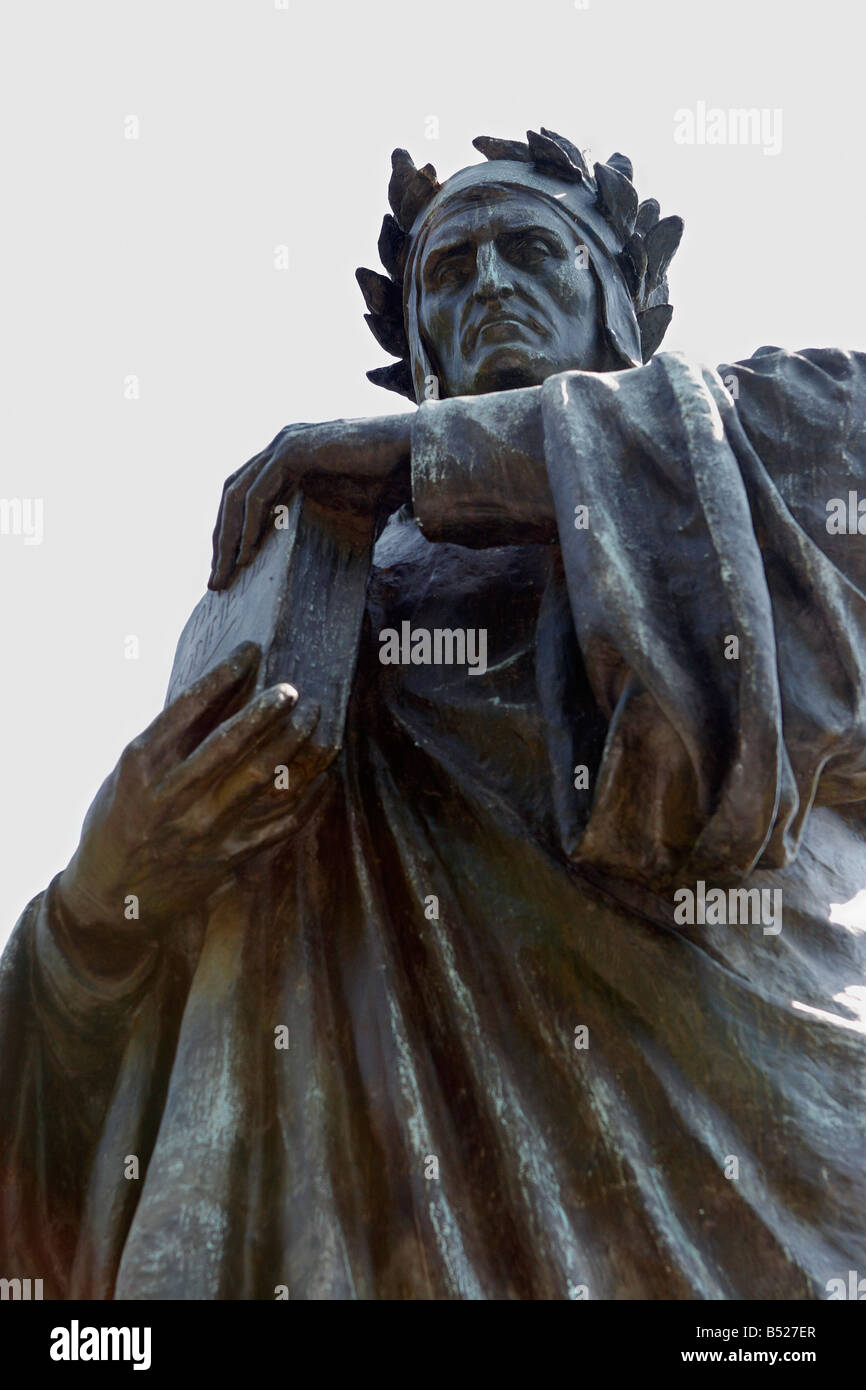 A statue of Dante Alighieri holding his book Divina Commedia in ...