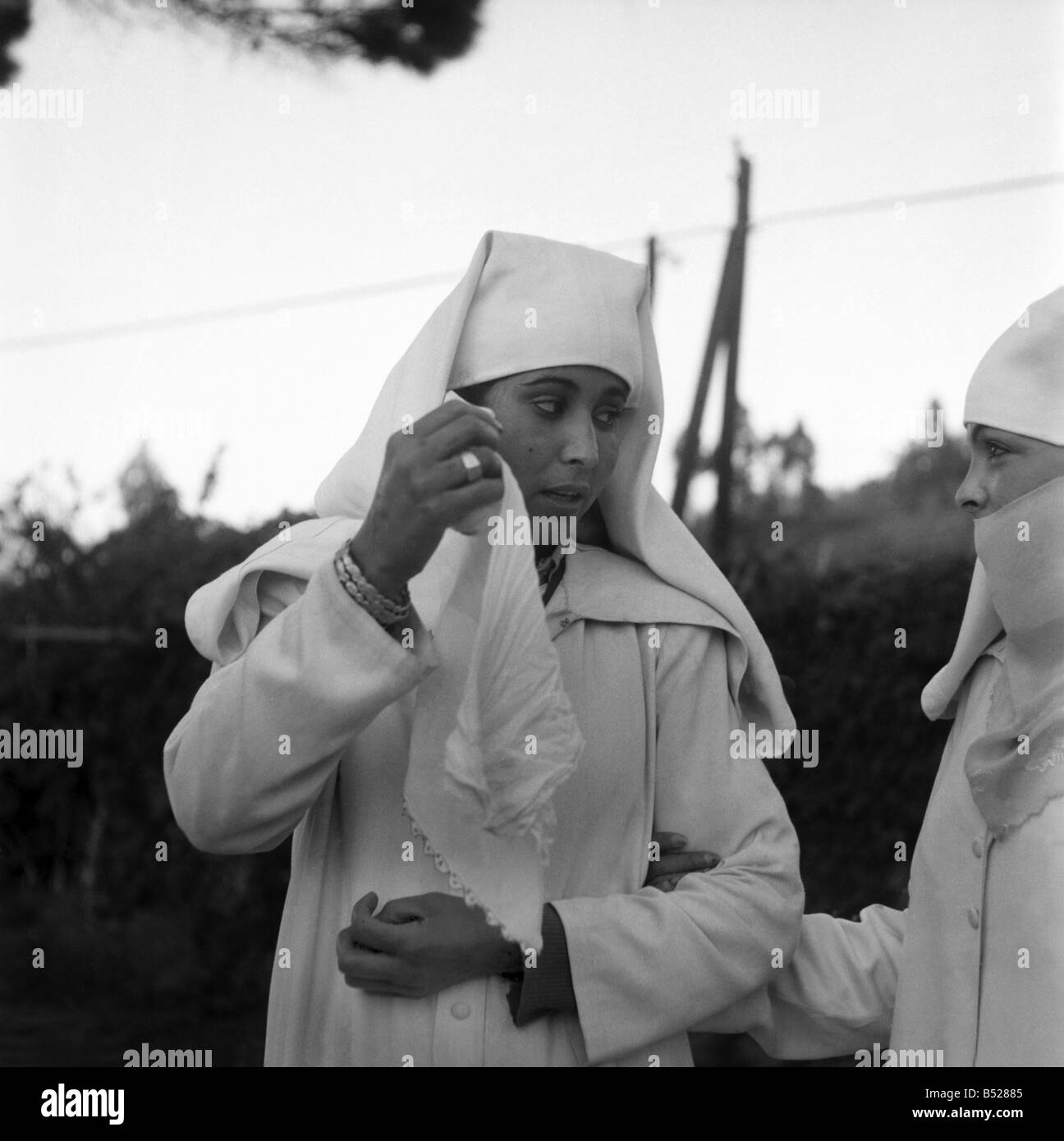Woman putting on a Djellabah traditional dress. January 1953 D216-014 ...