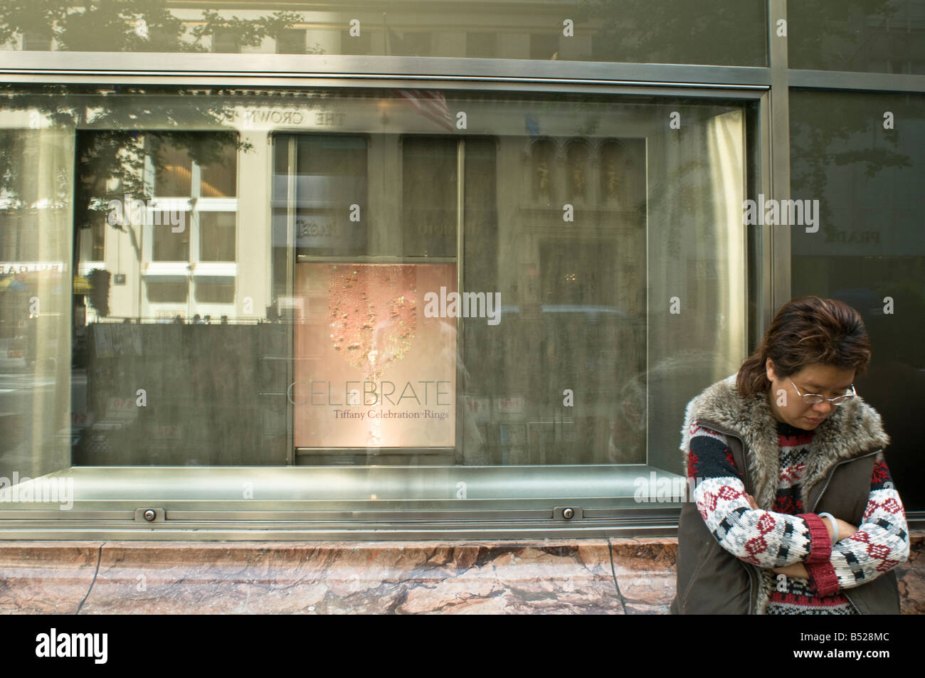 Woman outside store display window Stock Photo - Alamy