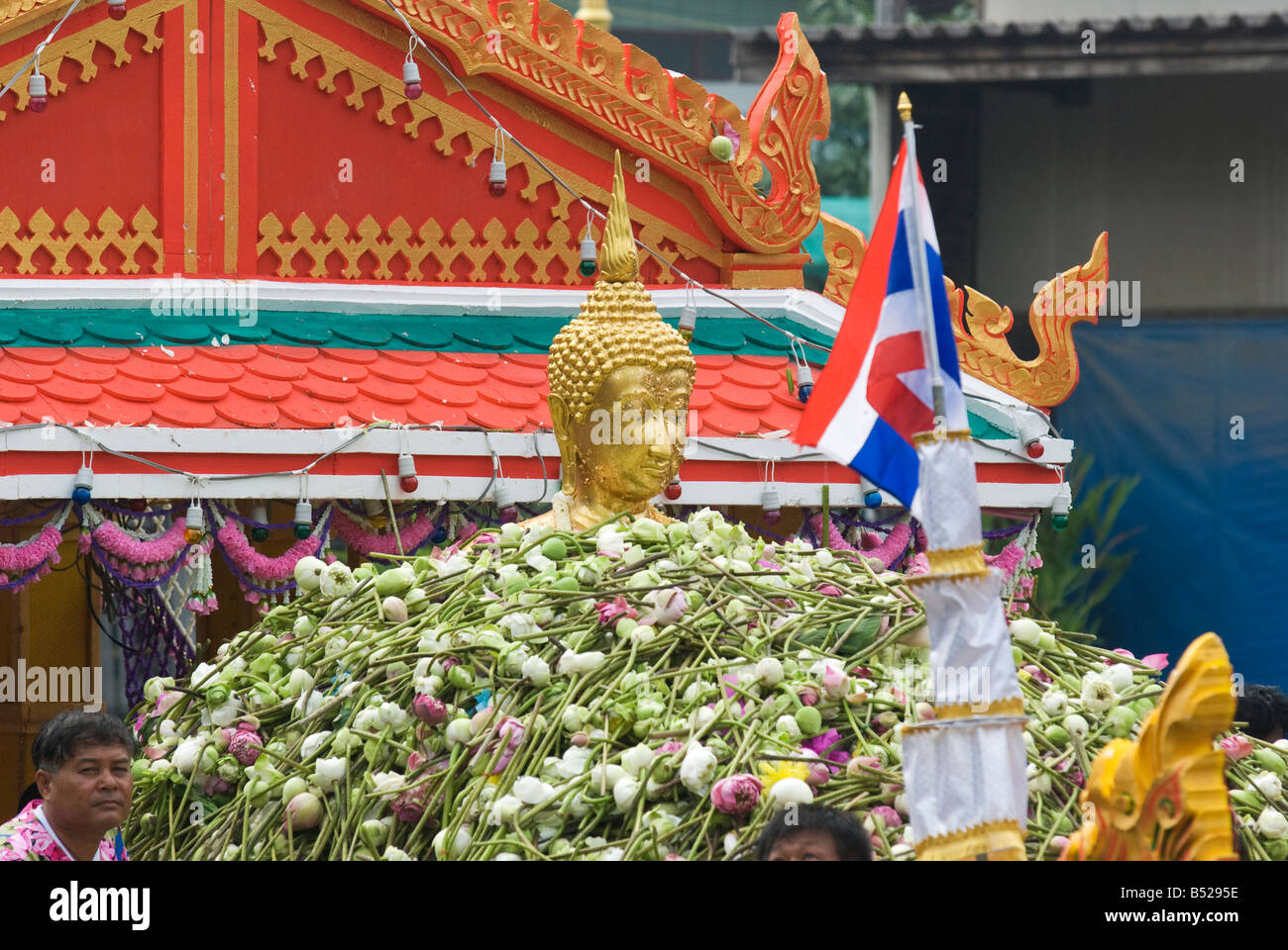 The floating Buddha image covered in lotus flowers on decorated barge ...