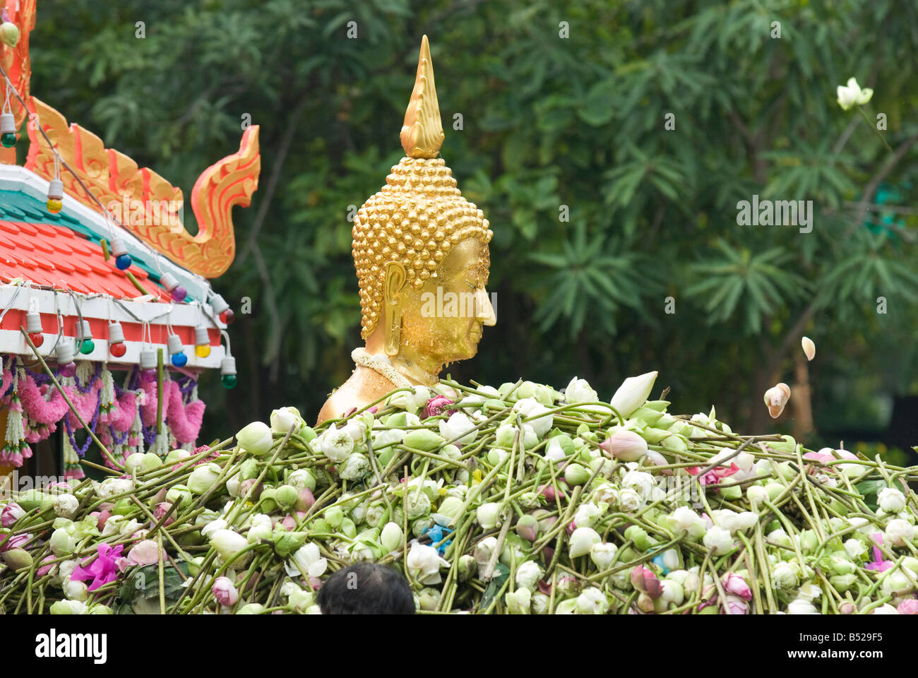 The floating Buddha image covered in lotus flowers on decorated barge ...