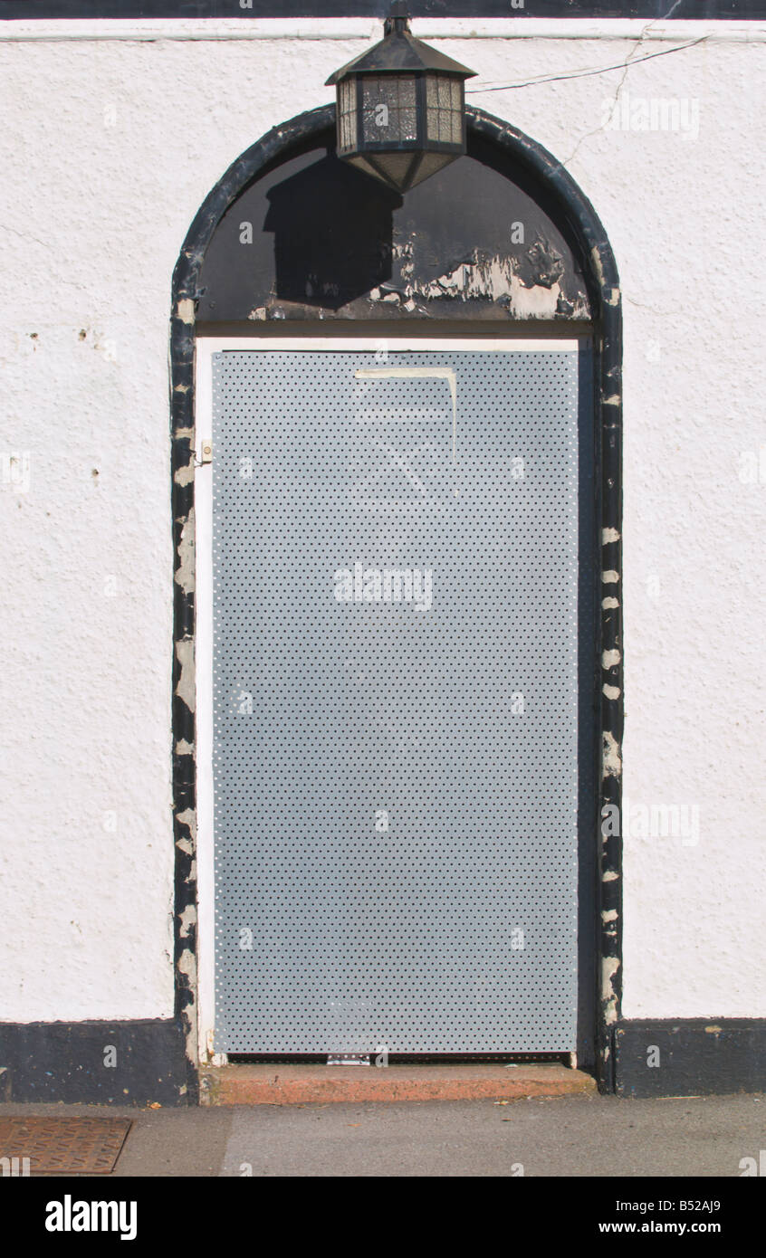 Halfway House pub front door boarded up with steel shutters and looking ...