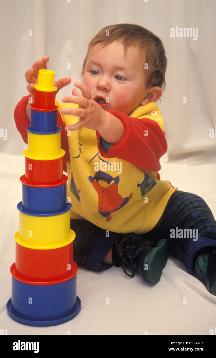 toddler building coloured tower Stock Photo - Alamy