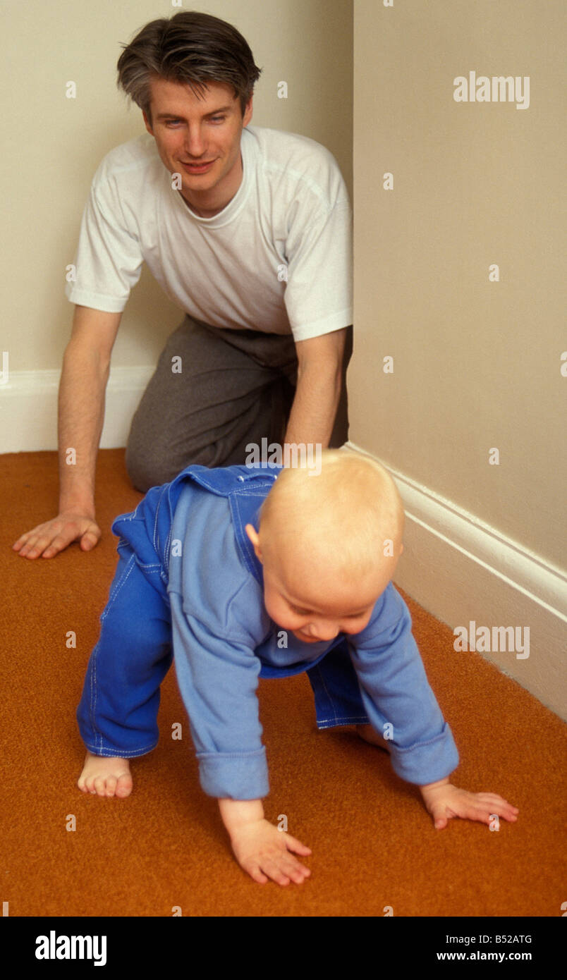 dad having fun with his baby chasing him along corridor Stock Photo - Alamy