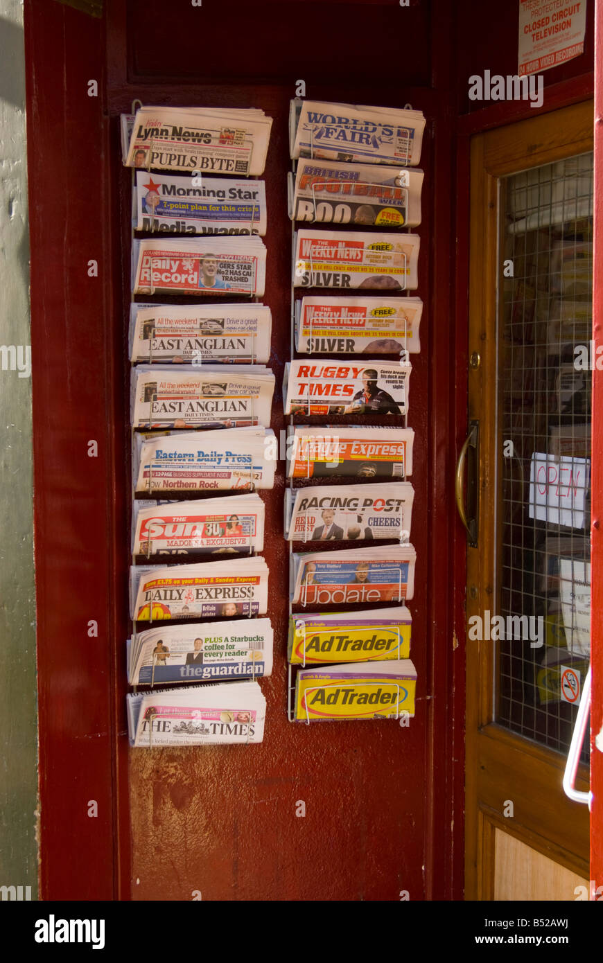 Display of various newspapers outside uk newsagents in rack Stock Photo ...