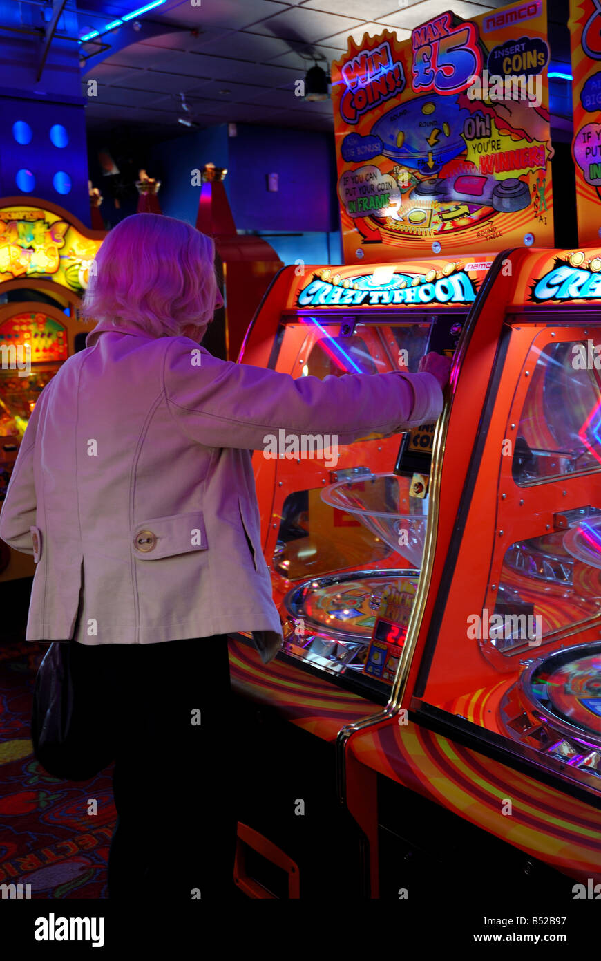 Senior woman playing slot machines hi-res stock photography and images ...