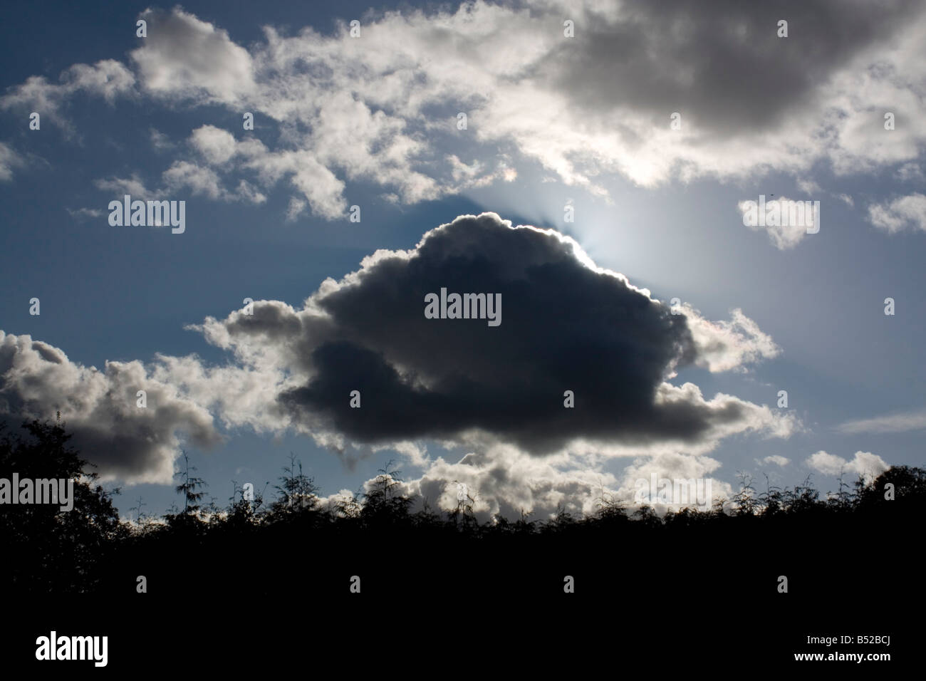 Storm cloud with silver lining and blue sky Cotswolds UK Stock Photo ...
