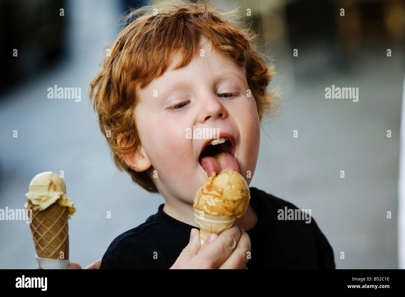 Young boy enjoying an ice cream Stock Photo - Alamy