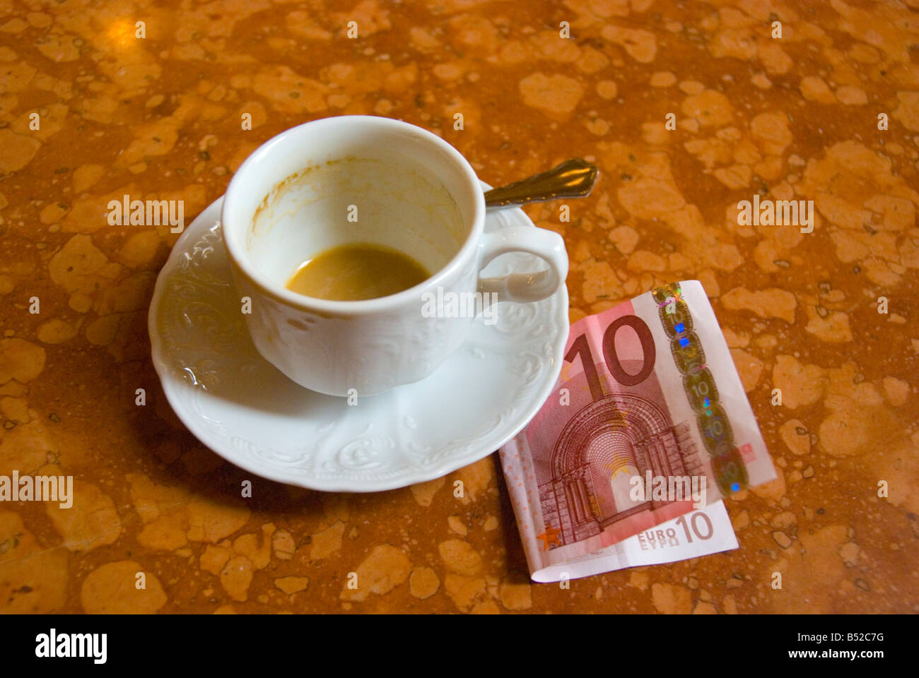 Empty coffee cup and a ten euro note in Cafe Central in Vienna Austria ...