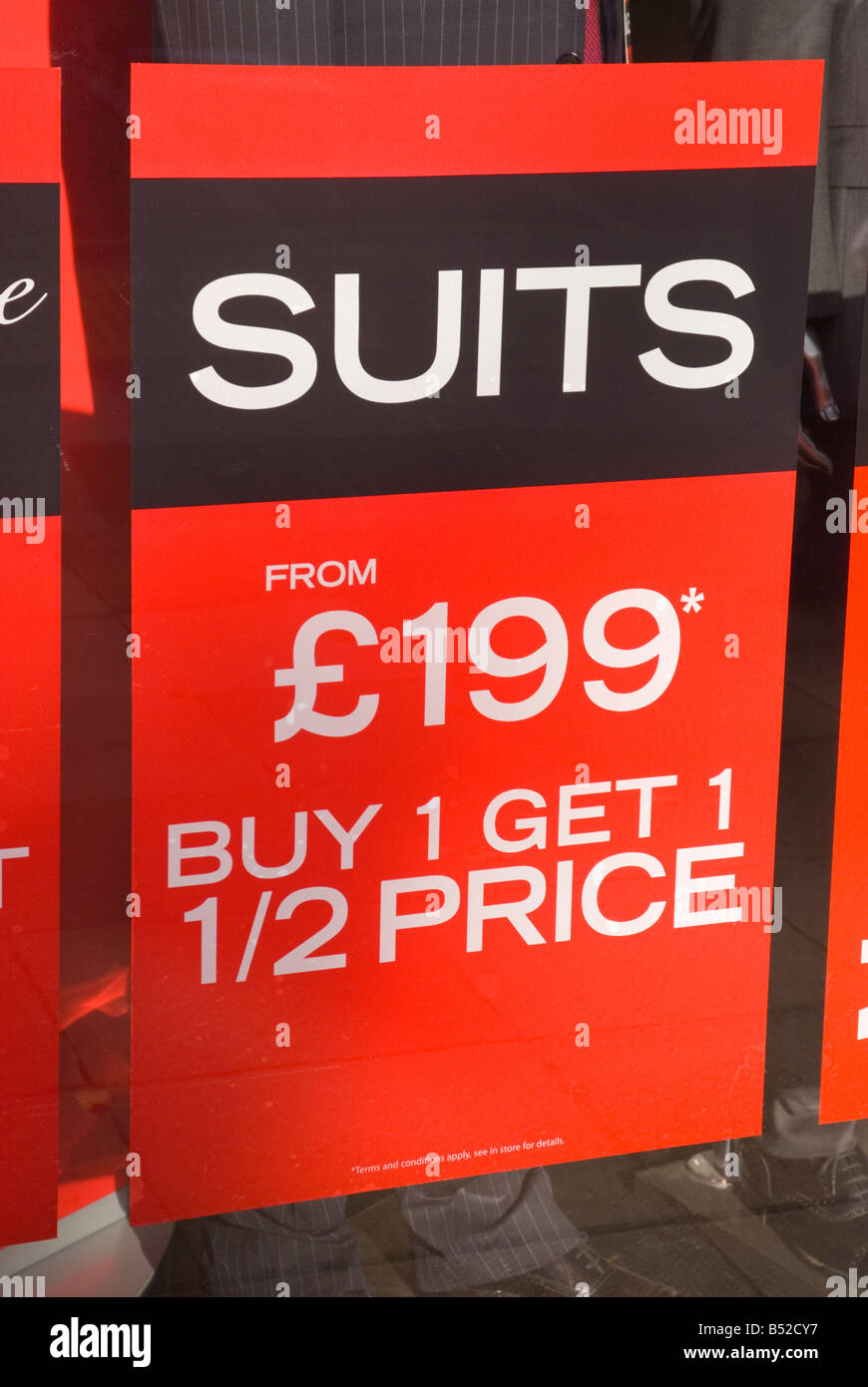 Sign advertising men's formal suits for sale in uk clothes shop window ...
