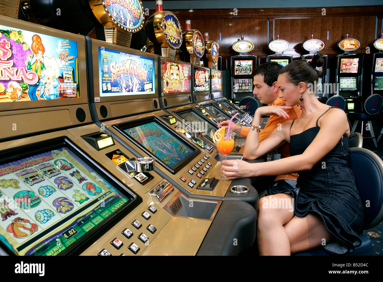 Girl playing fruit machine hi-res stock photography and images - Alamy