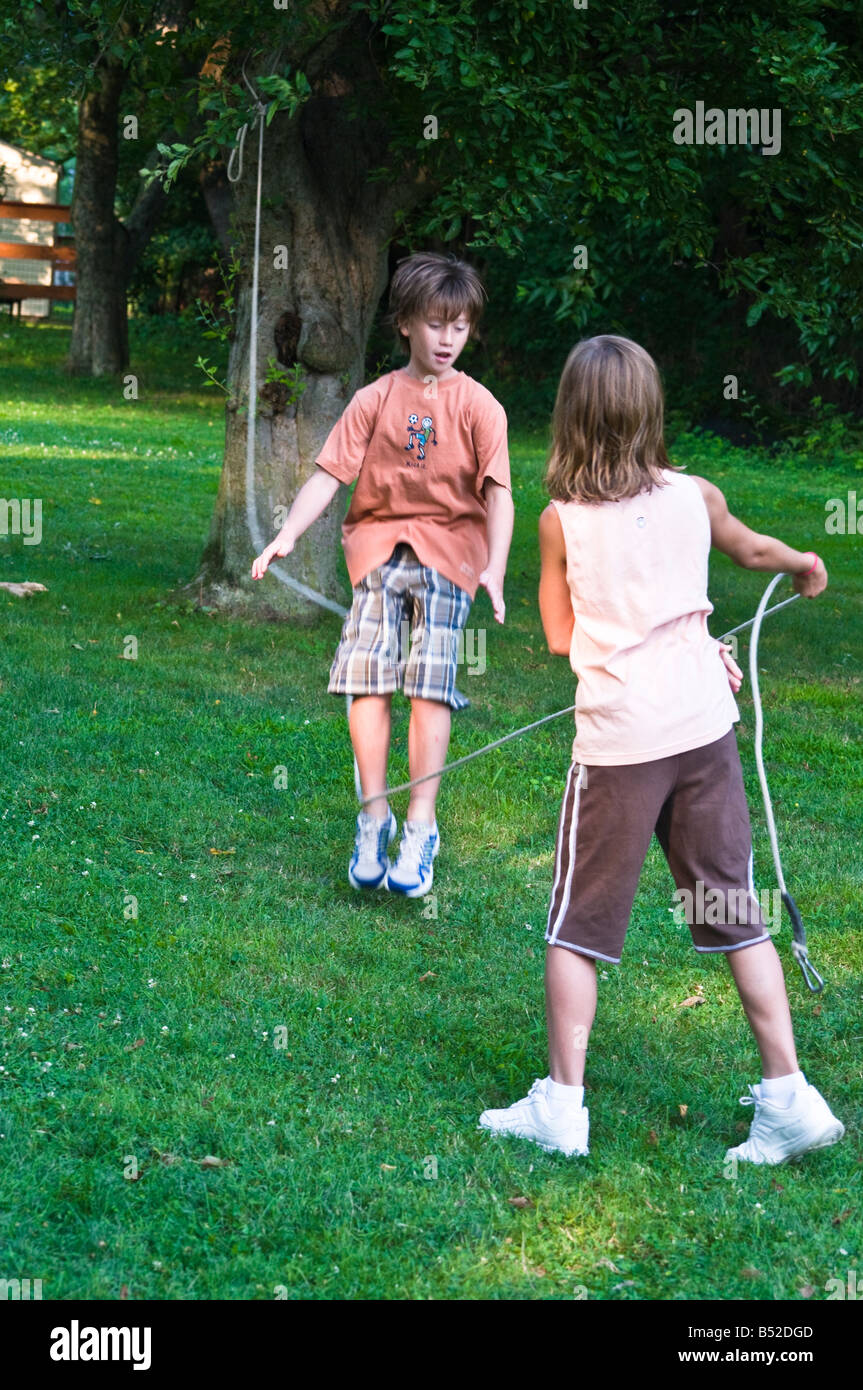 young girls jumping rope at family summer picnic outing Stock Photo - Alamy
