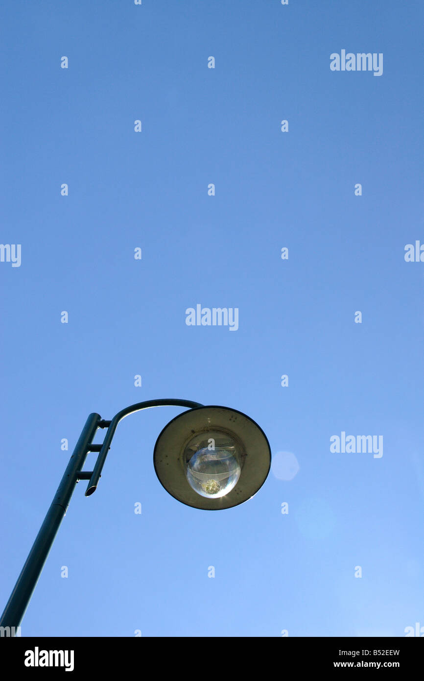 Lamp post viewed from below against blue sky Stock Photo - Alamy