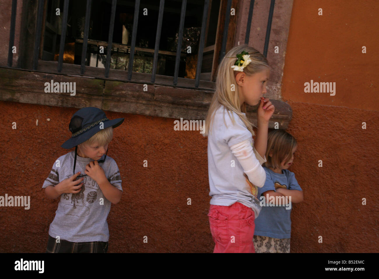 Three children looking bored while waiting for their parents Stock ...