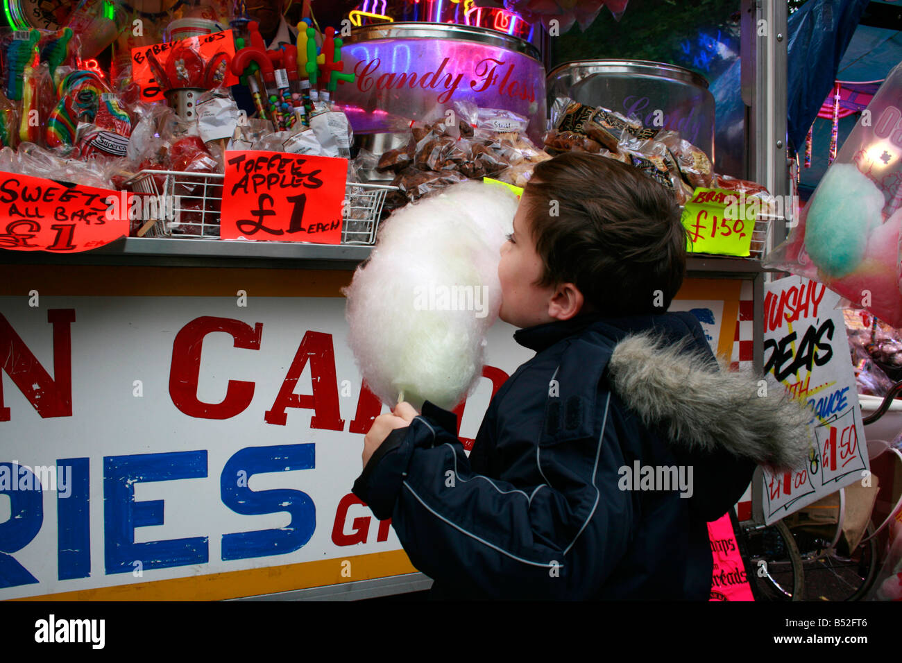 seven year old boy eating candy flow at Nottinghams Goose Fair Stock ...