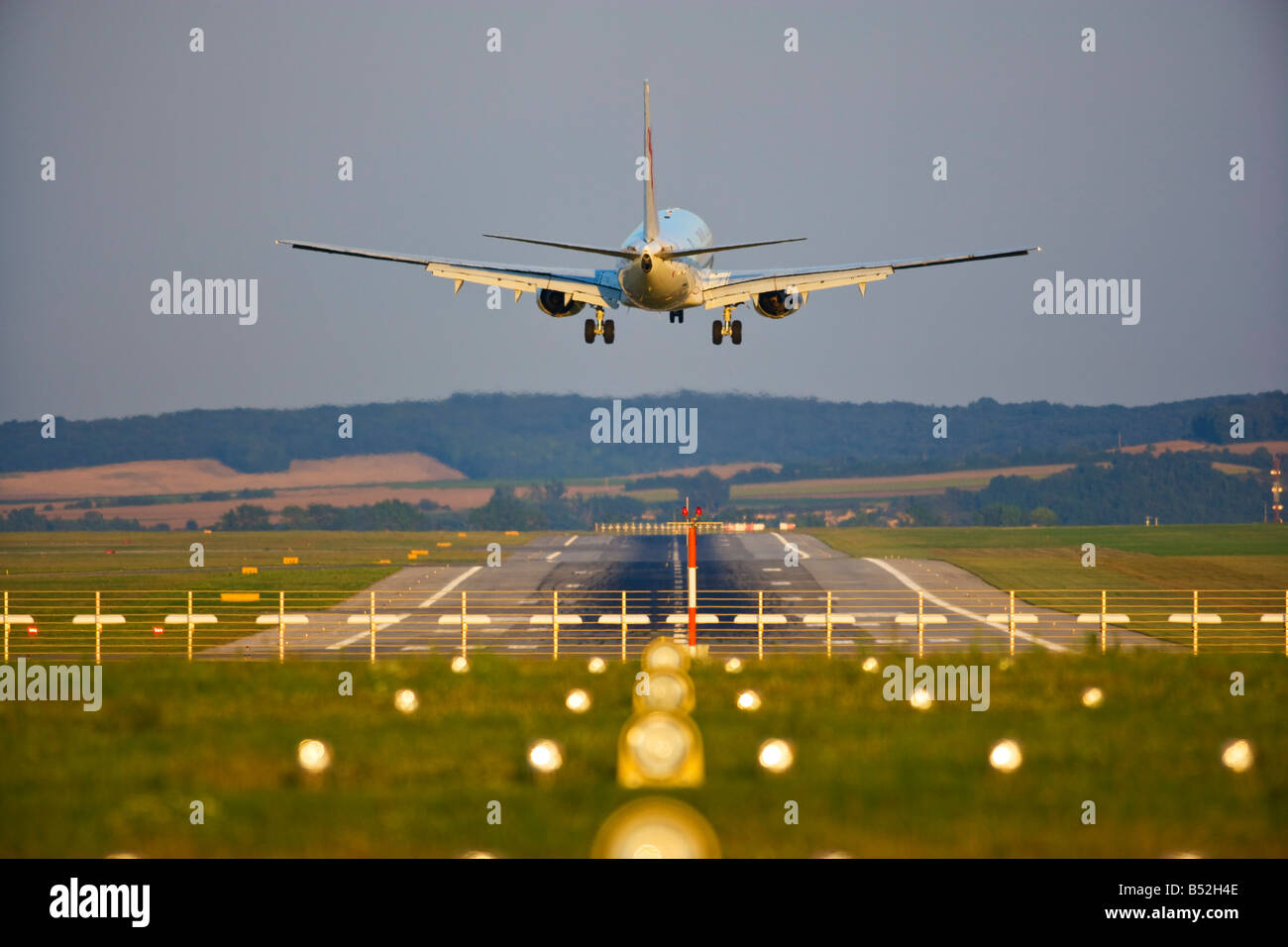 Landing aircraft on final approach. The runway lights can be seen in ...