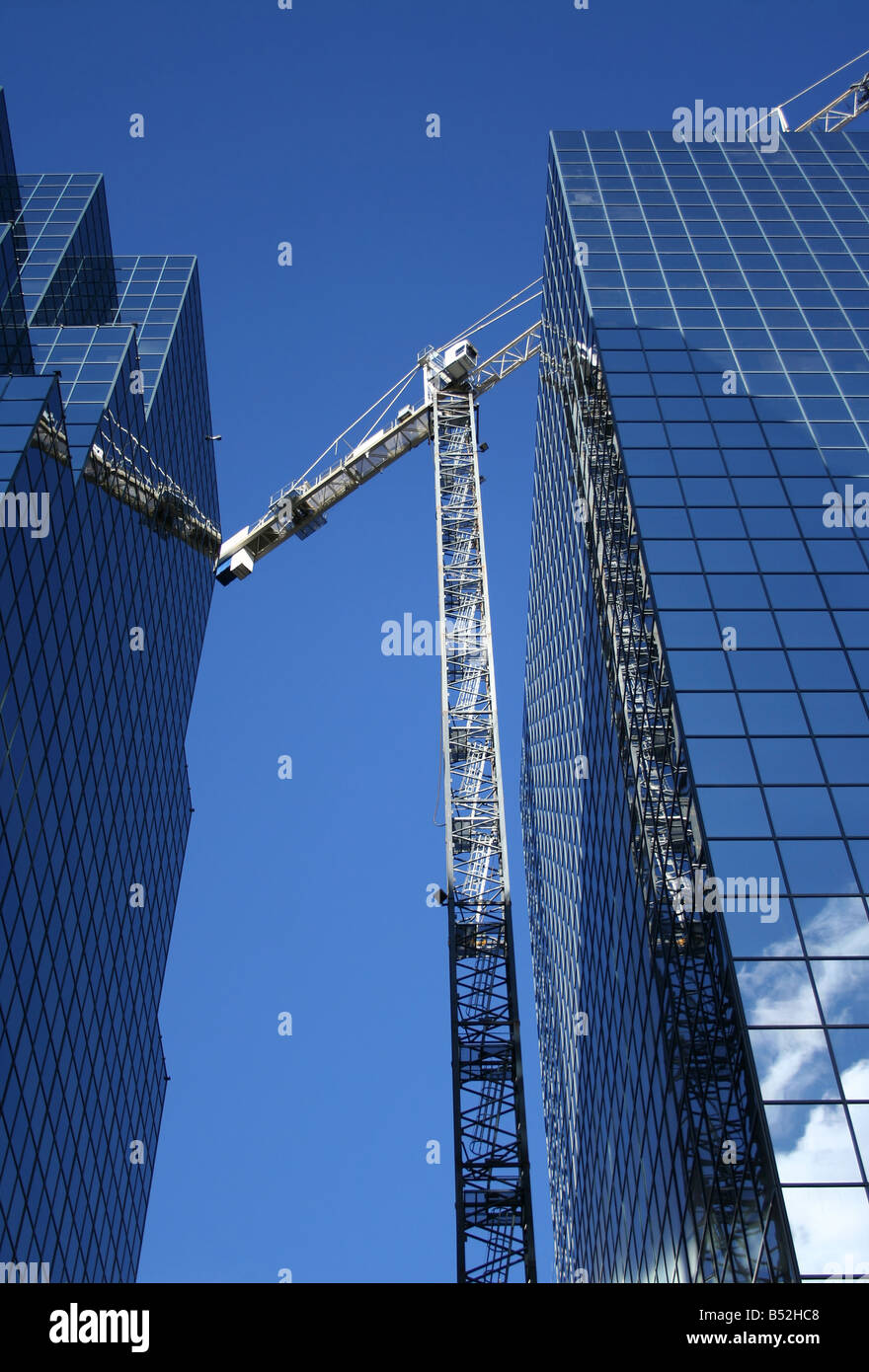 Skyscraper construction crane surrounded by glass towers Stock Photo ...