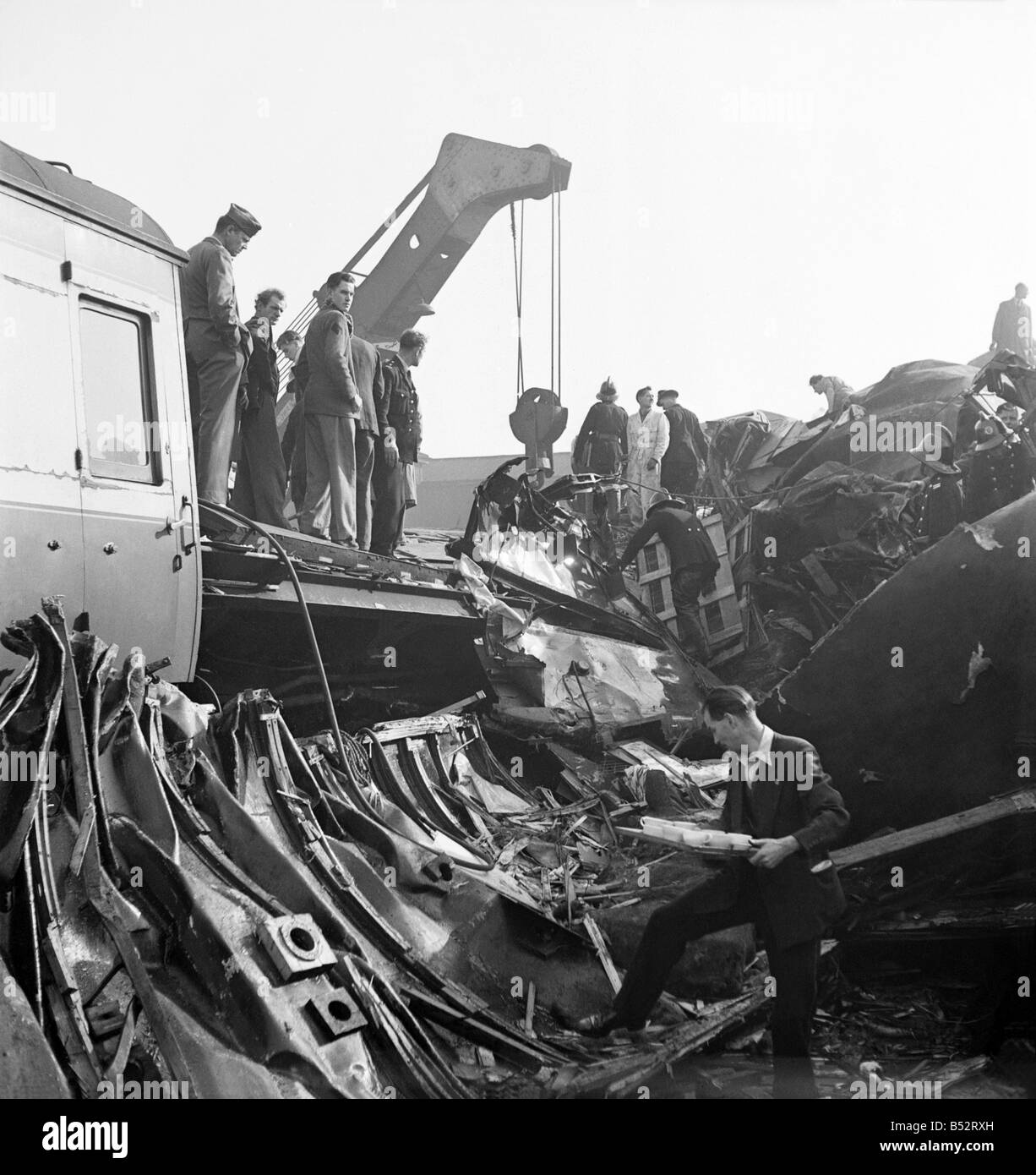 Harrow and Wealdstone Train Crash. Wreckage and bodies are cleared away ...