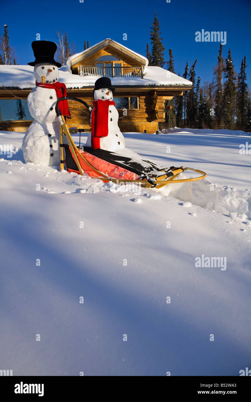 Large & small snowman ride on dog sled in deep snow in afternoon in ...