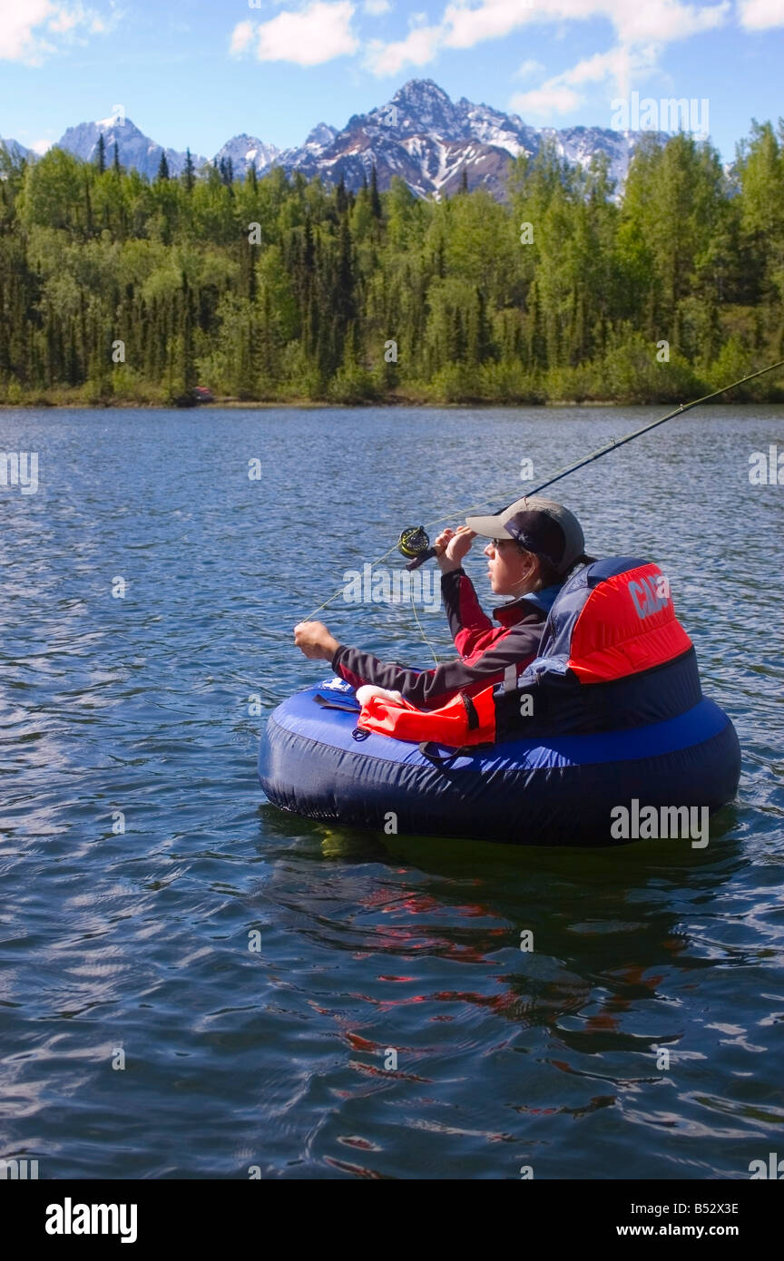 Fly fisherwoman in float tube casts for rainbow trout on Weiner Lake in ...