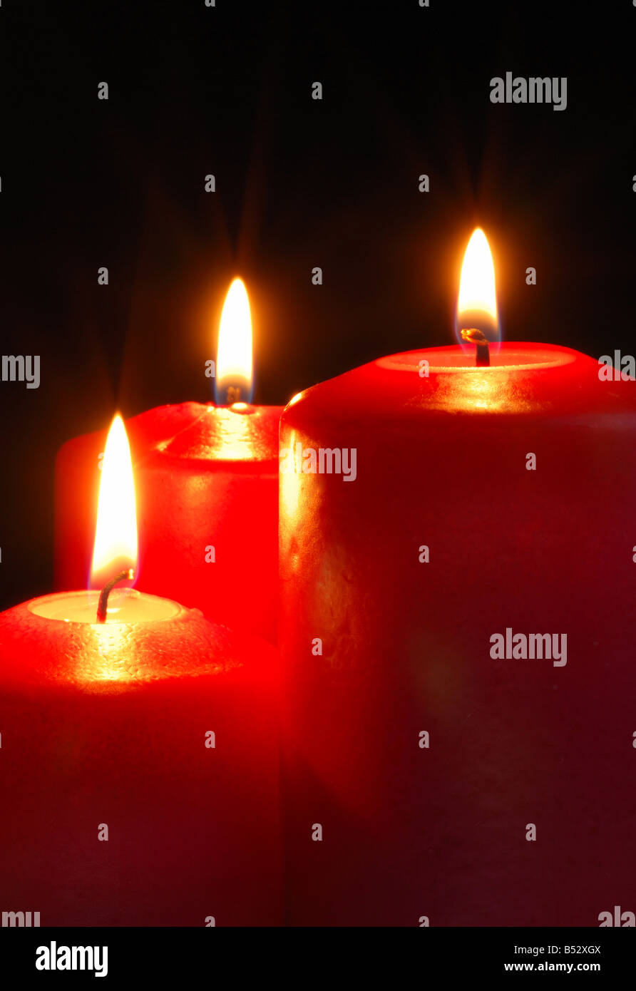 Candle A burning flame of a candle of red color Stock Photo - Alamy