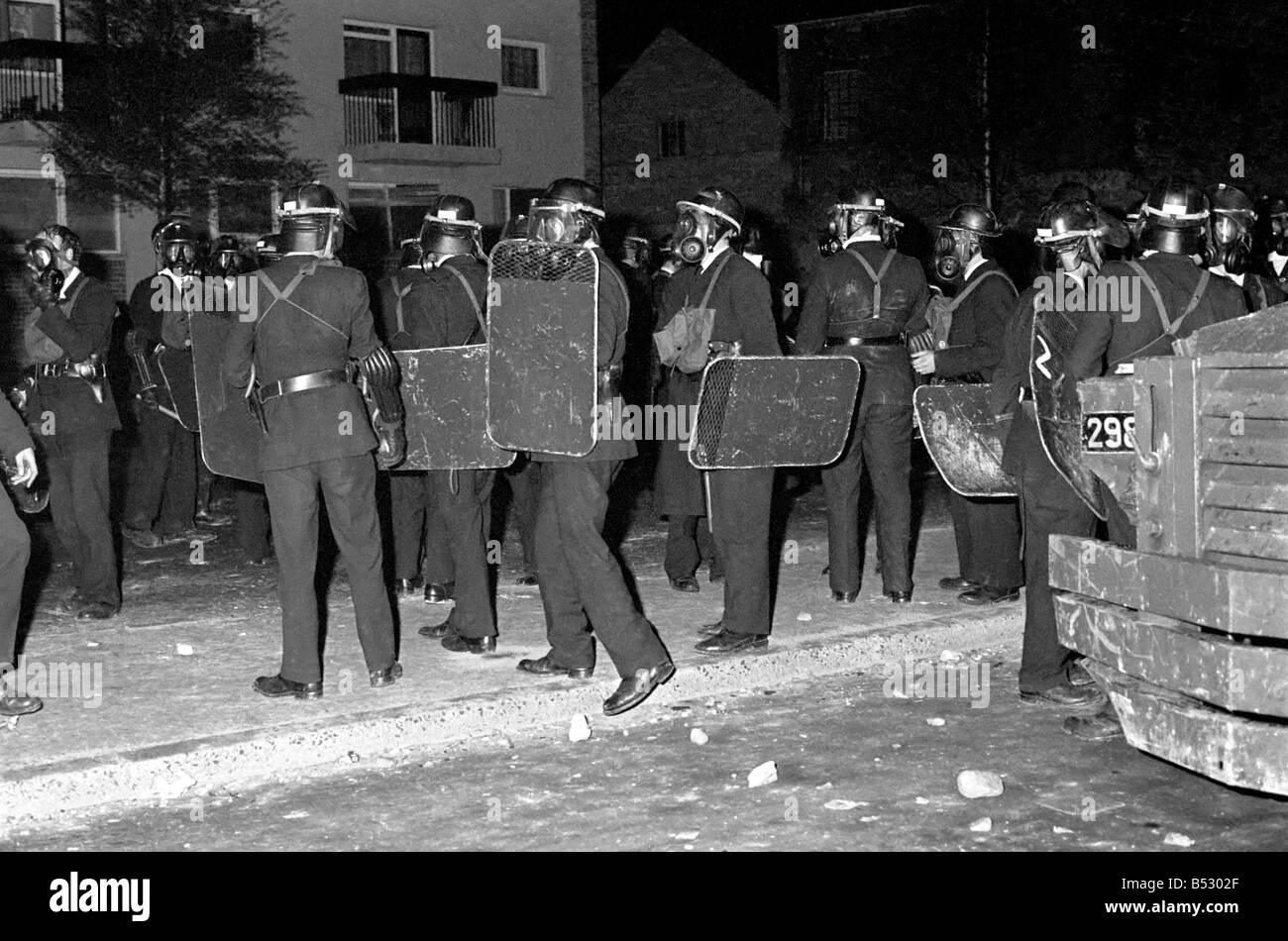 Policeman wearing gas masks and shields prepare a baton charge at ...