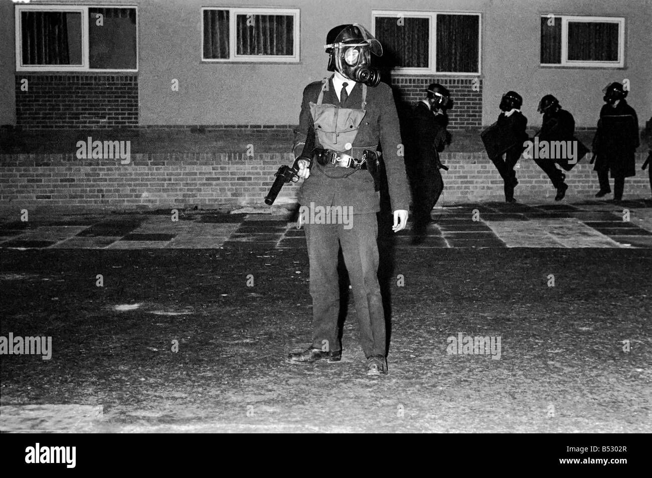 Policeman wearing gas masks and shields prepare a baton charge at ...