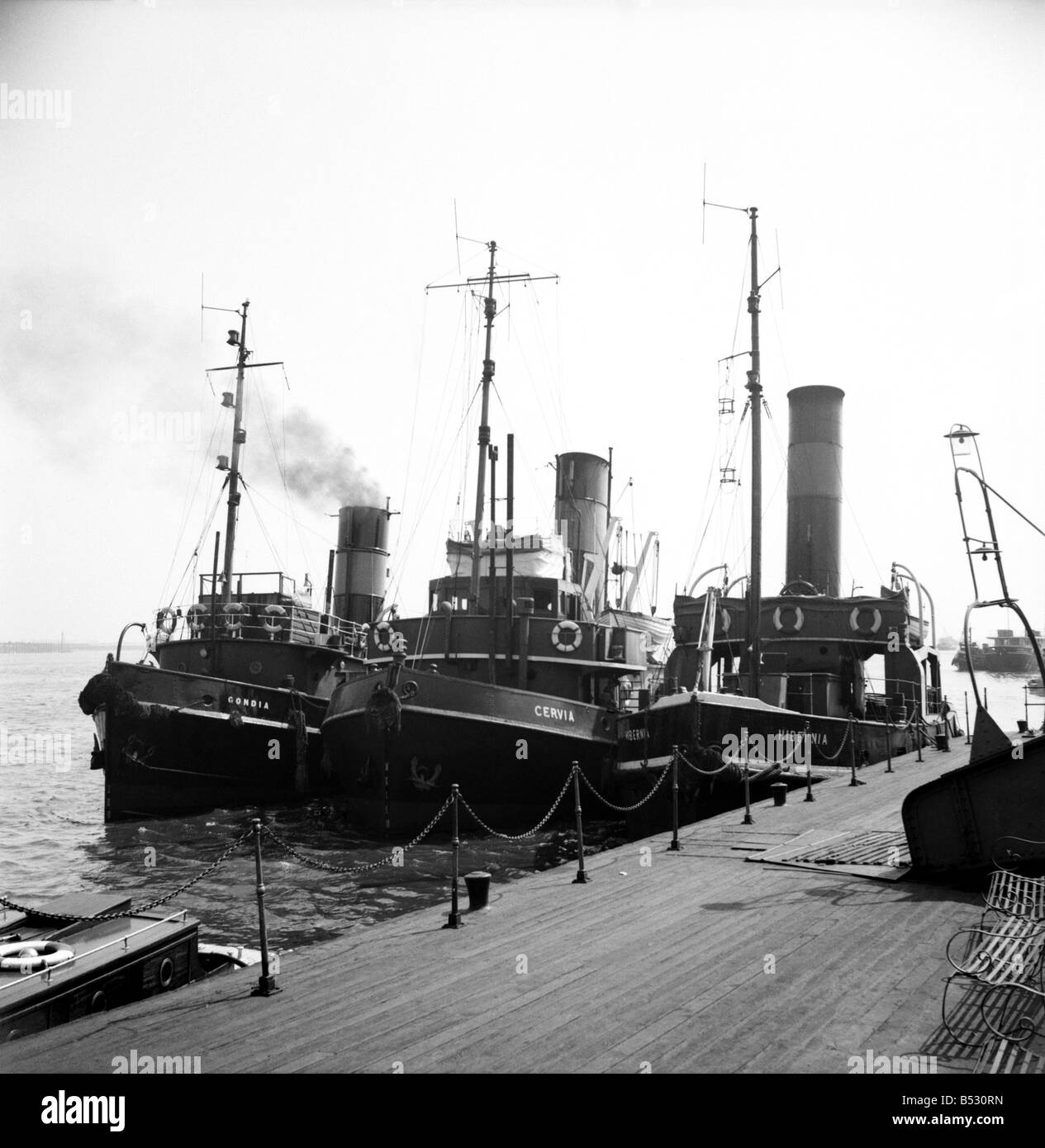 The Tug boats tied up alongside dock. June 1952 C3046-001 Stock Photo ...