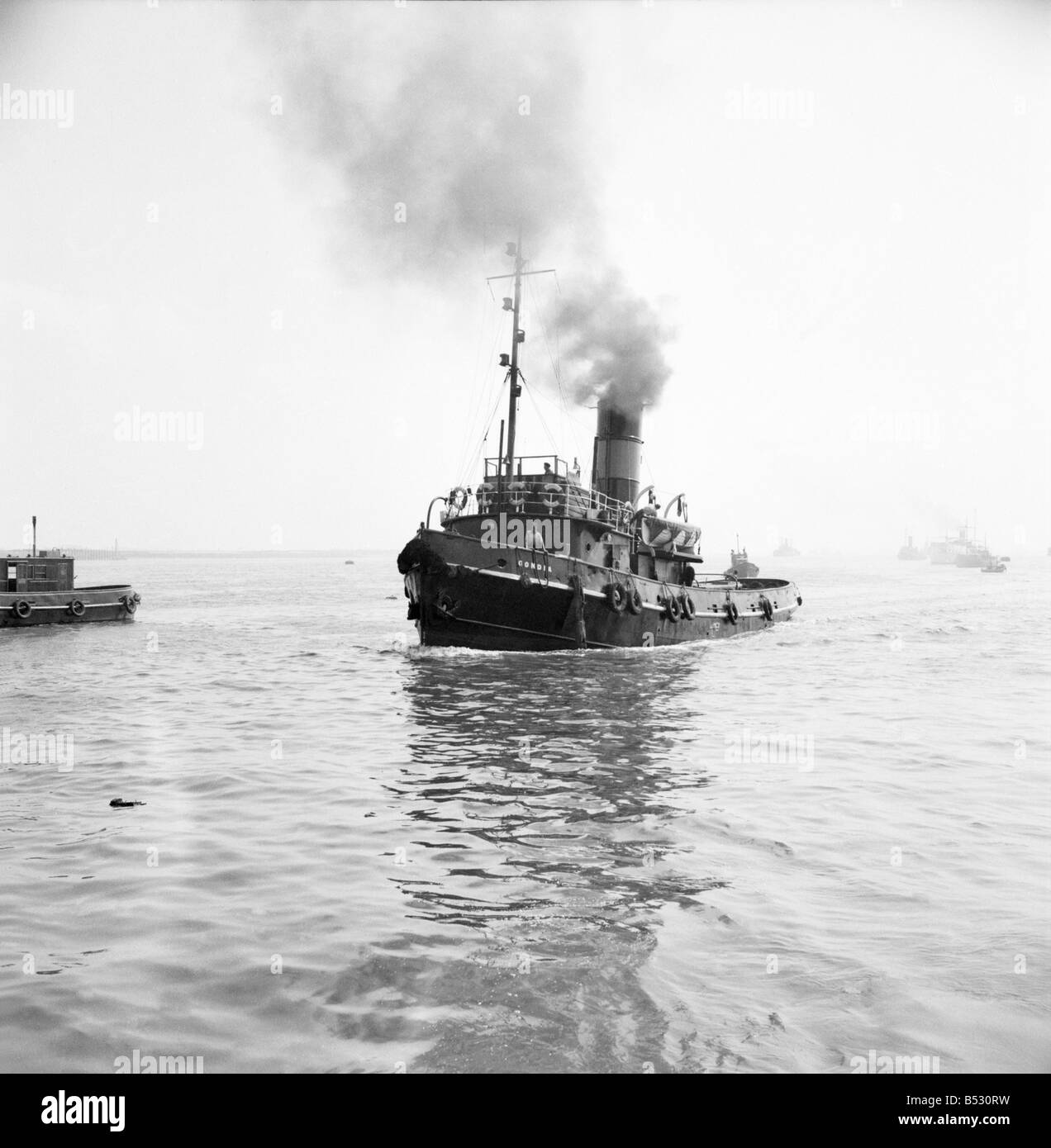 The Tug boat entering port . June 1952 C3046-002 Stock Photo - Alamy