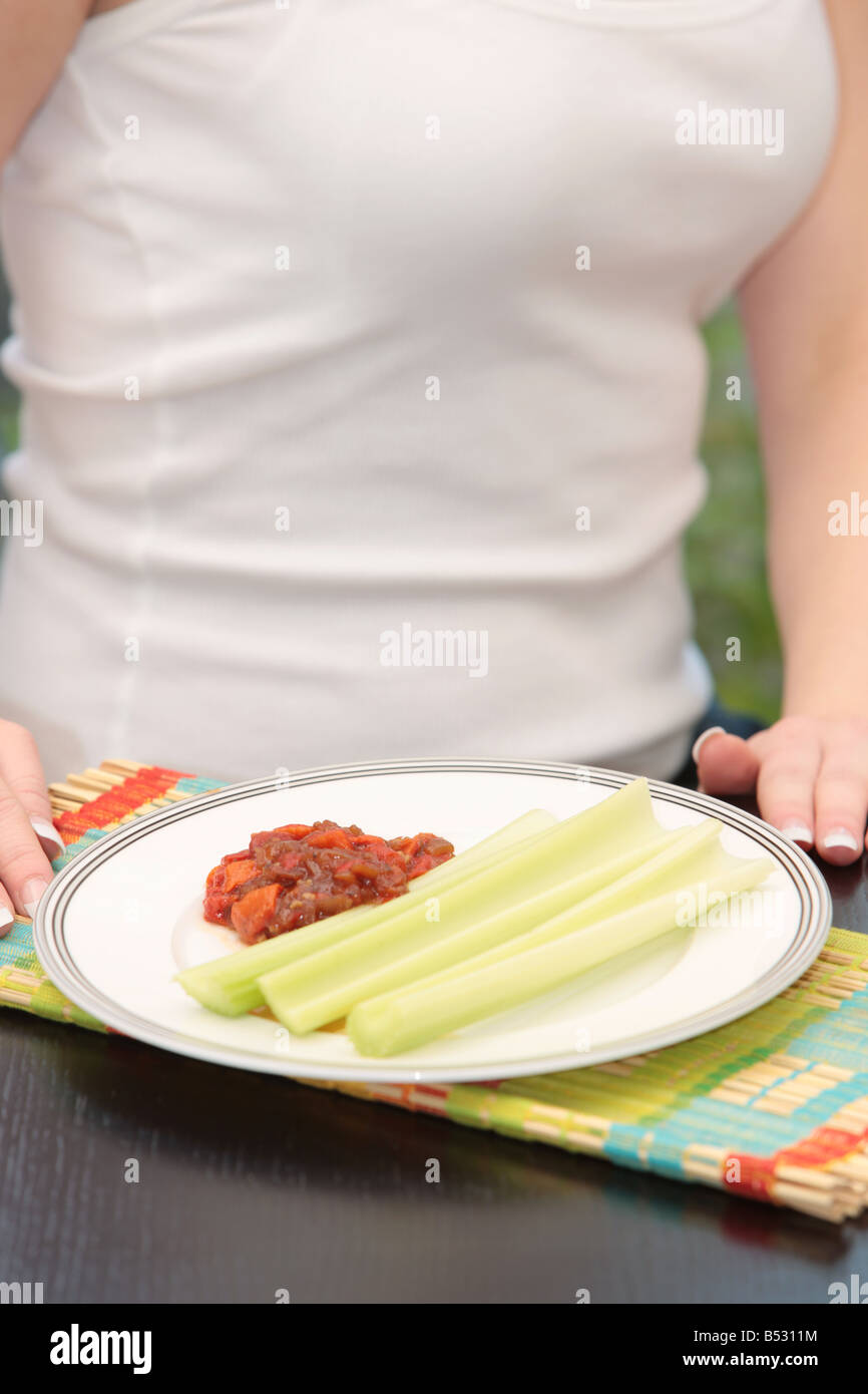 Young Woman Eating Celery and Salsa Model Released Stock Photo - Alamy