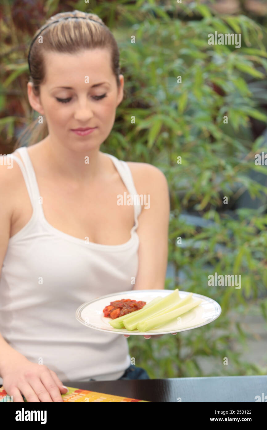 Young Woman Eating Celery and Salsa Model Released Stock Photo - Alamy
